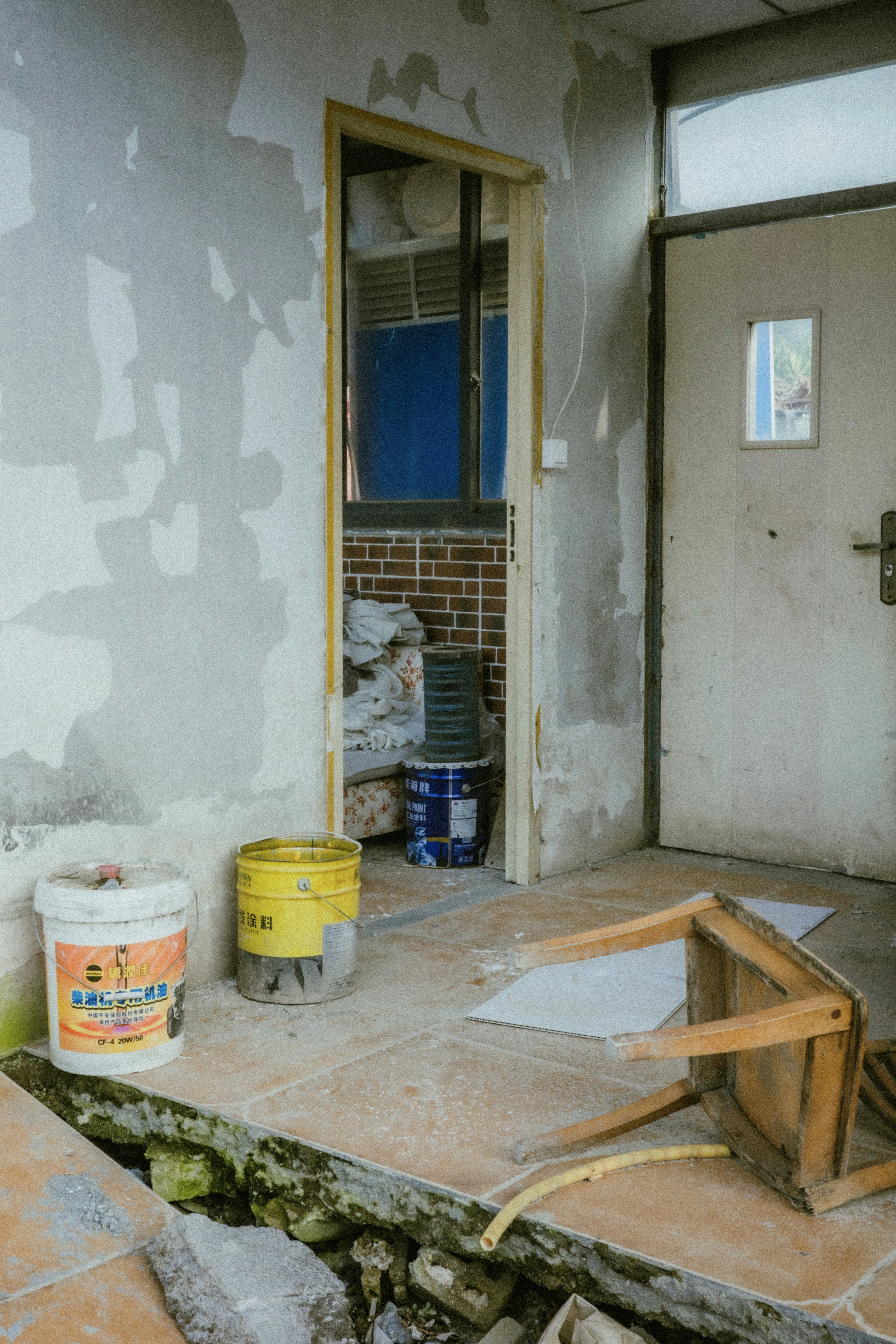 Construction Zone Entrance: Weathered Doorway Framed by Bare Walls