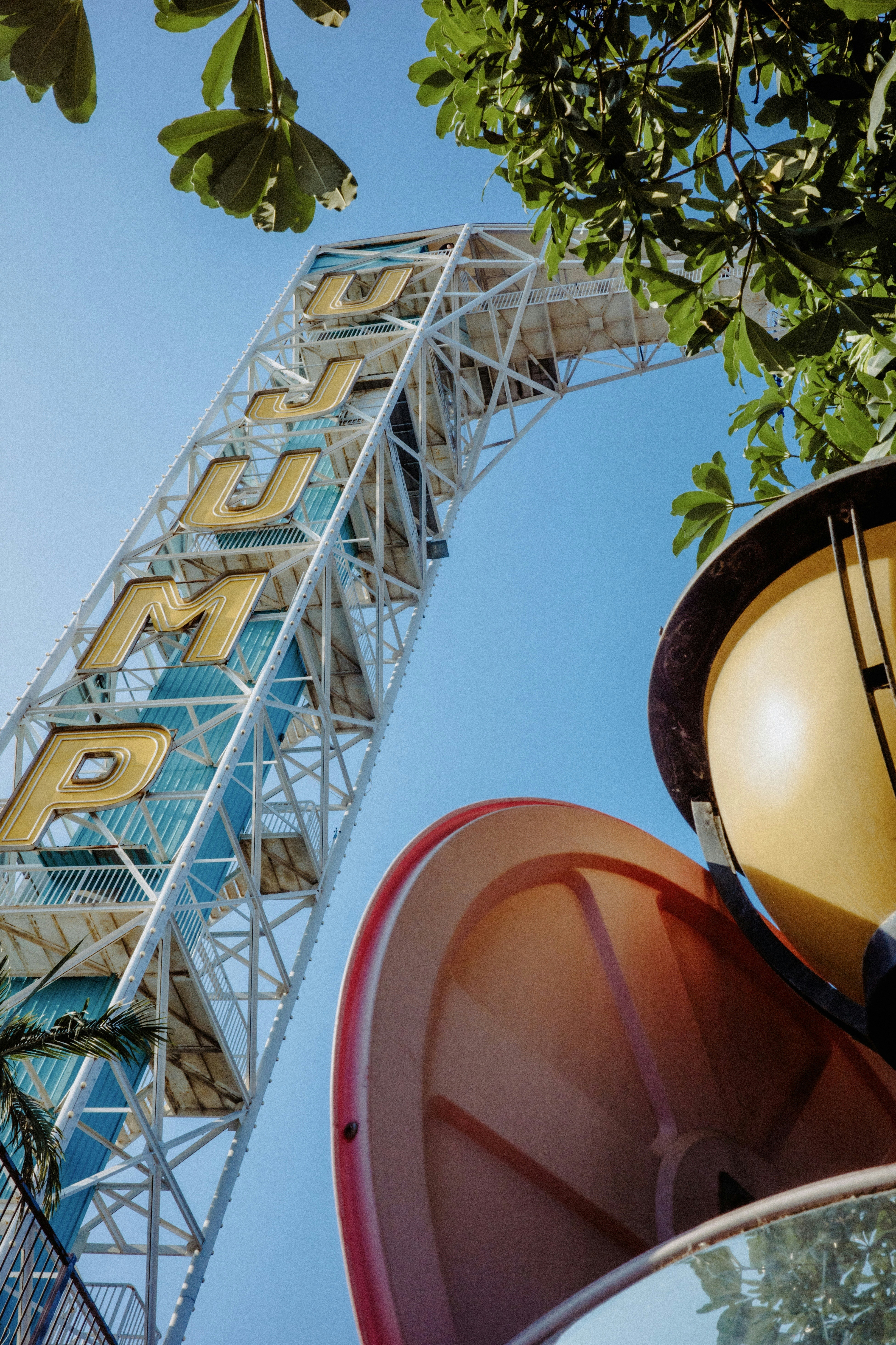 Giant Ferris Wheel of Neon Letters Rising Against a Clear Sky