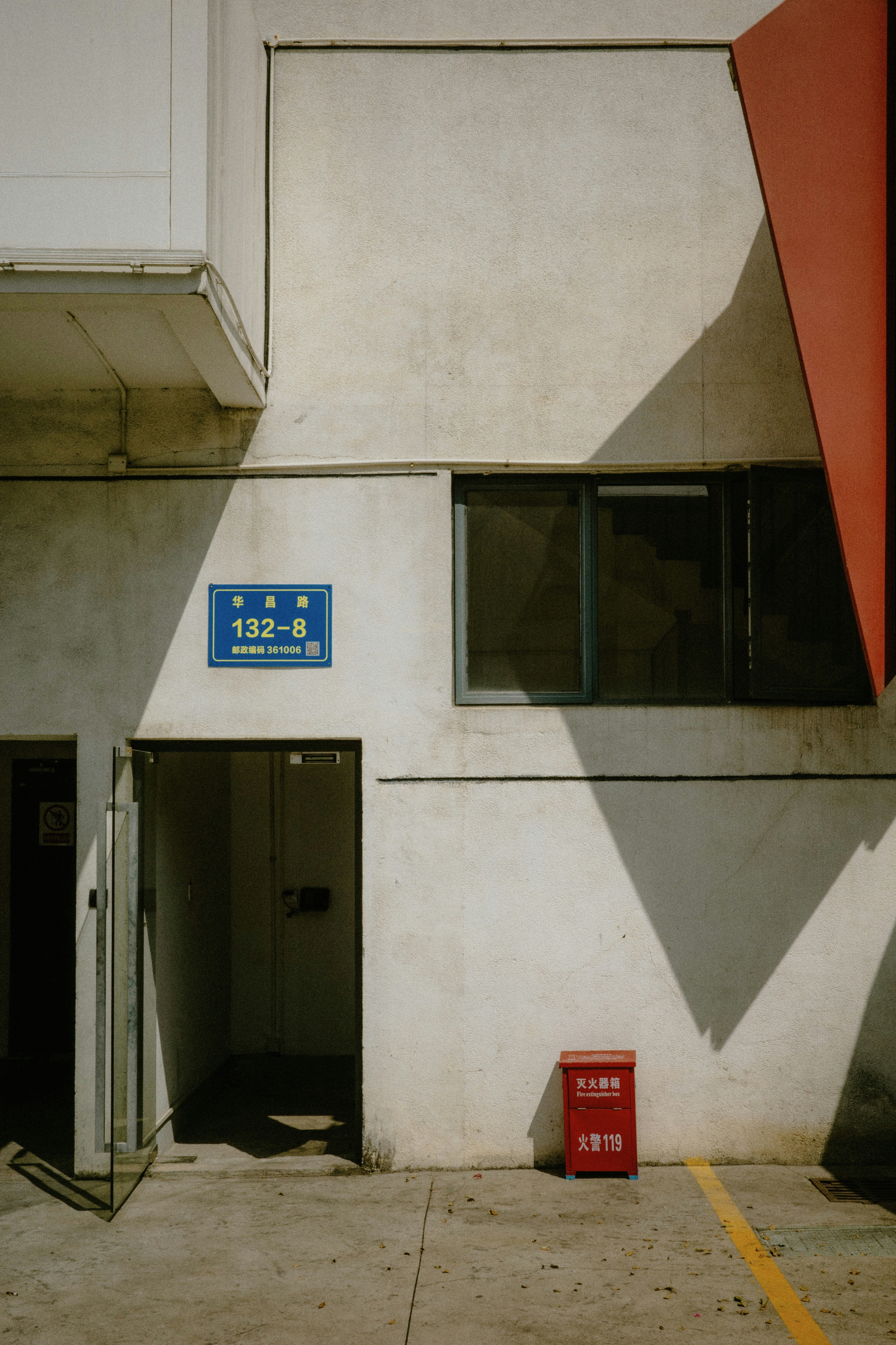 Shadowed doorway under angular orange canopy