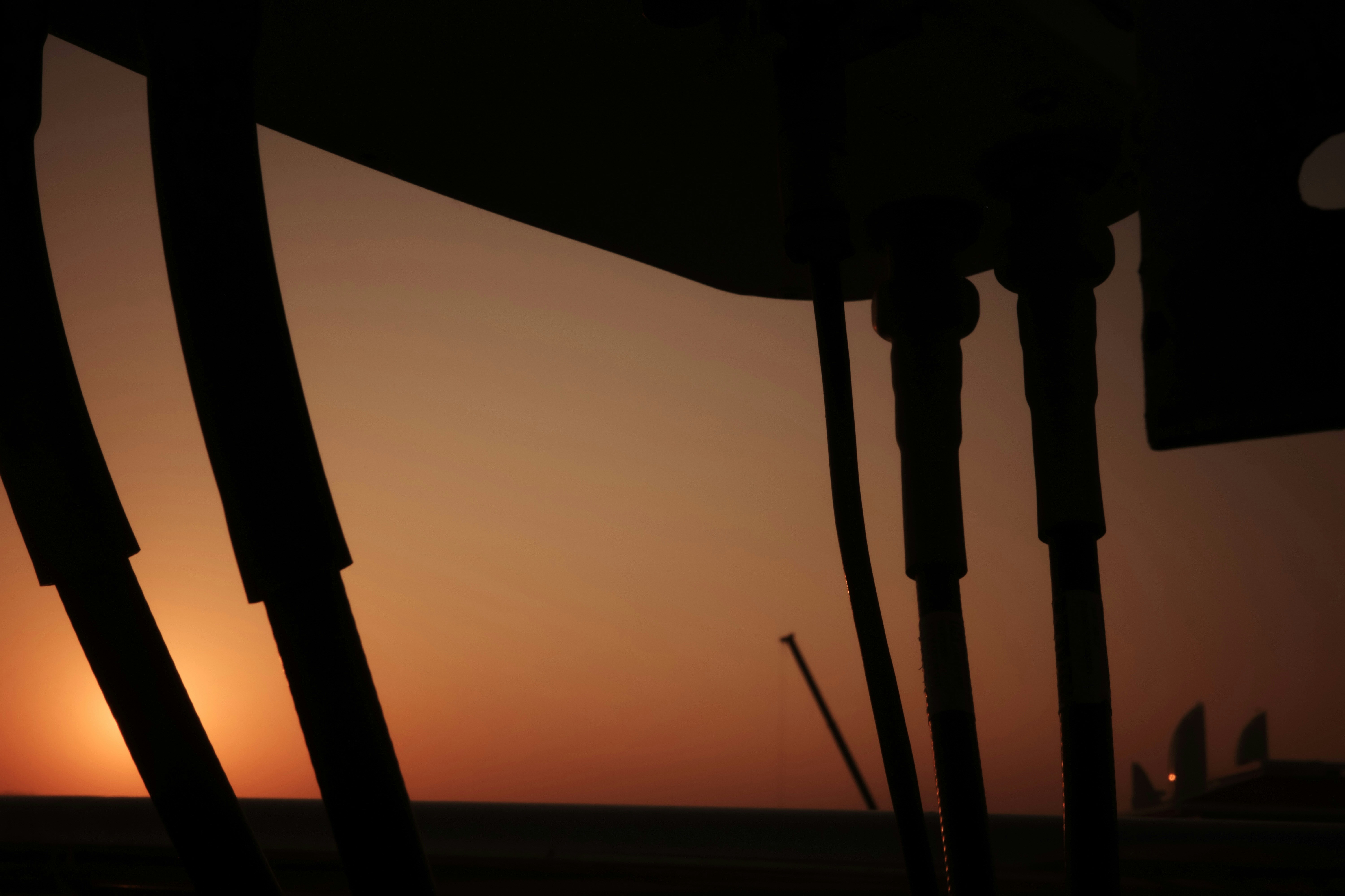 Silhouetted Machinery at Sunset: Quiet Port of Shadows