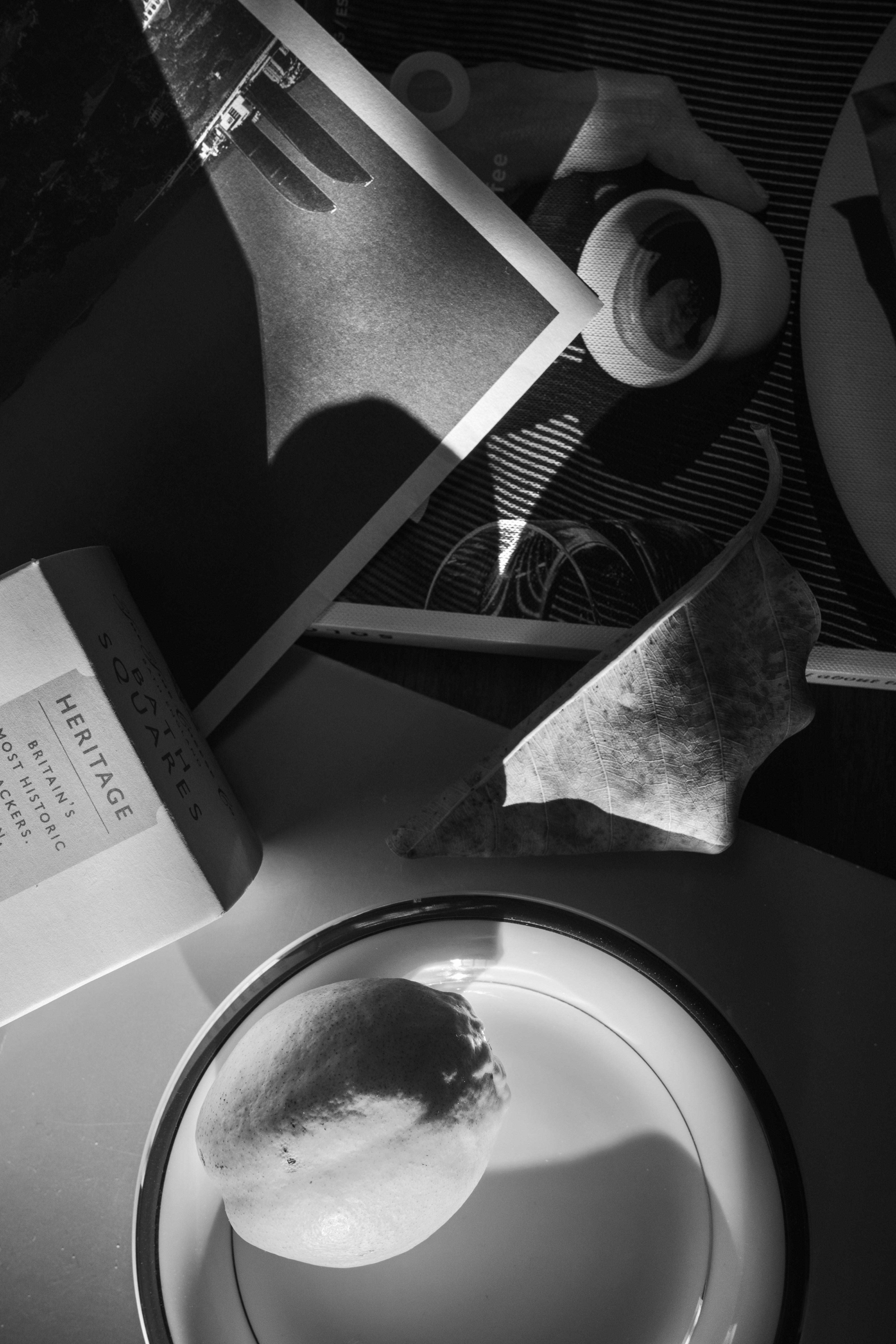 A book, cup, and leaf arranged on a table. photo – Free Paper Image on ...