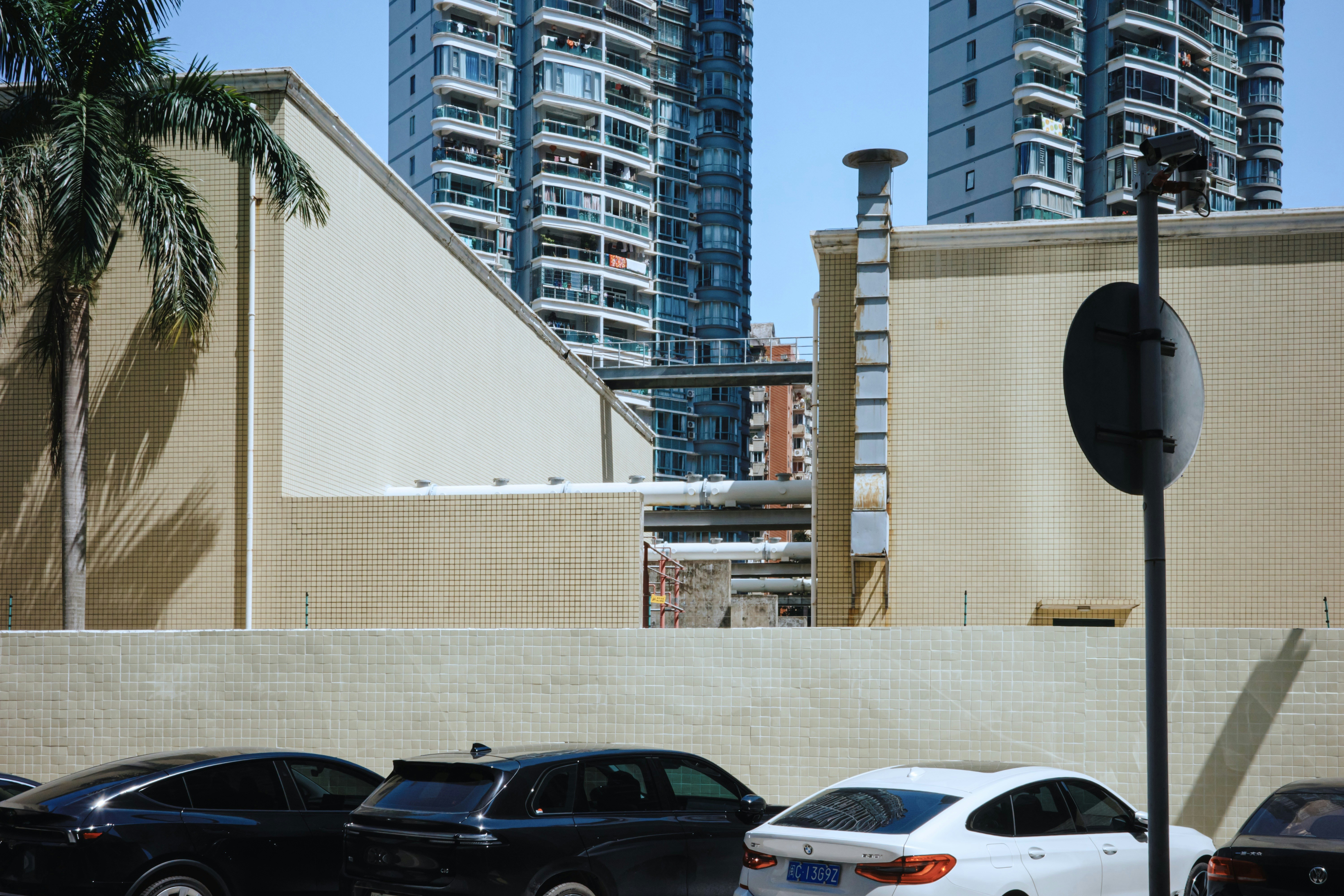 Urban Plateau: Cars Parked Beneath a Modern Cityscape