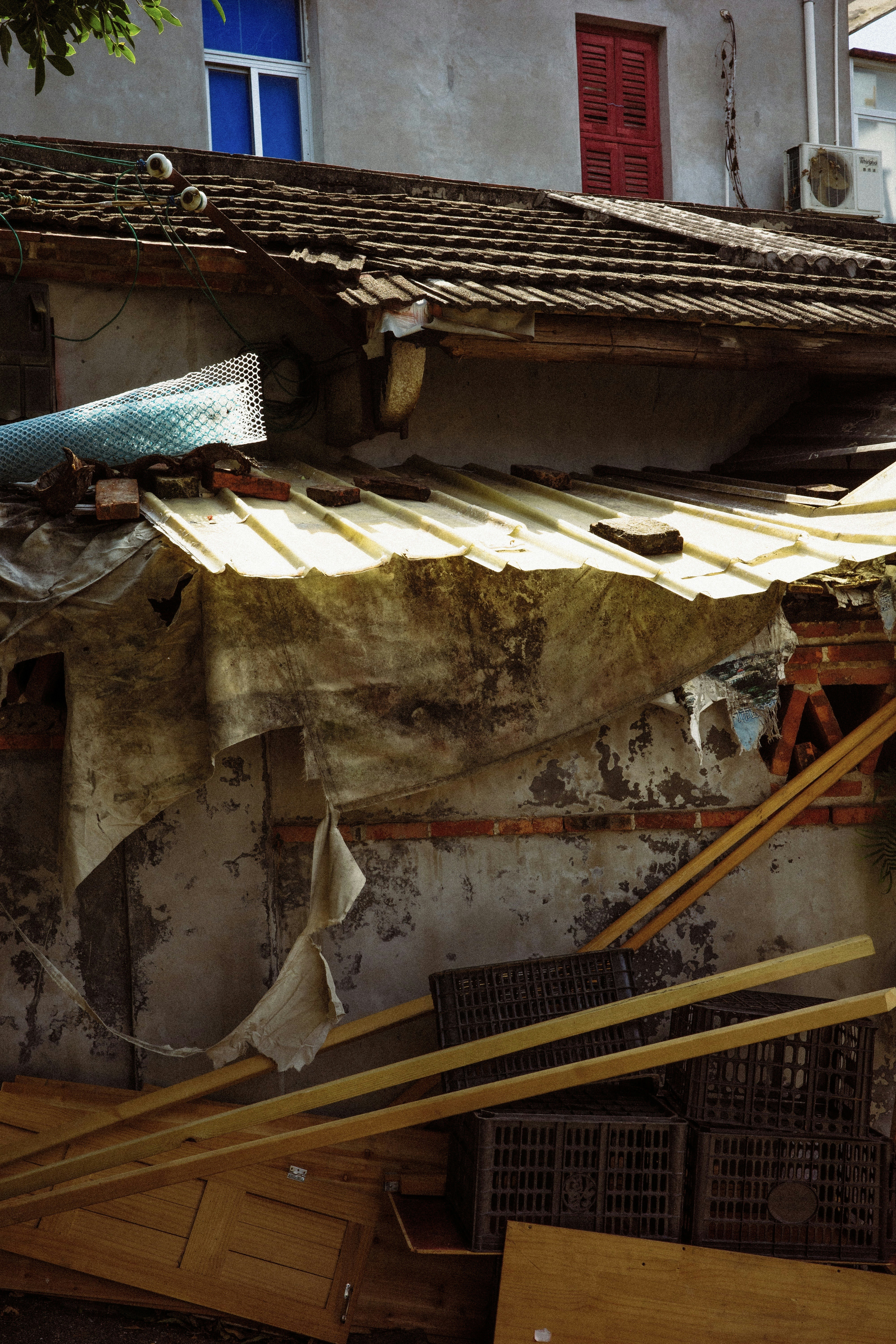 Rubble and Rooflines: A Slice of Urban Decay Under Sunlit Tarp
