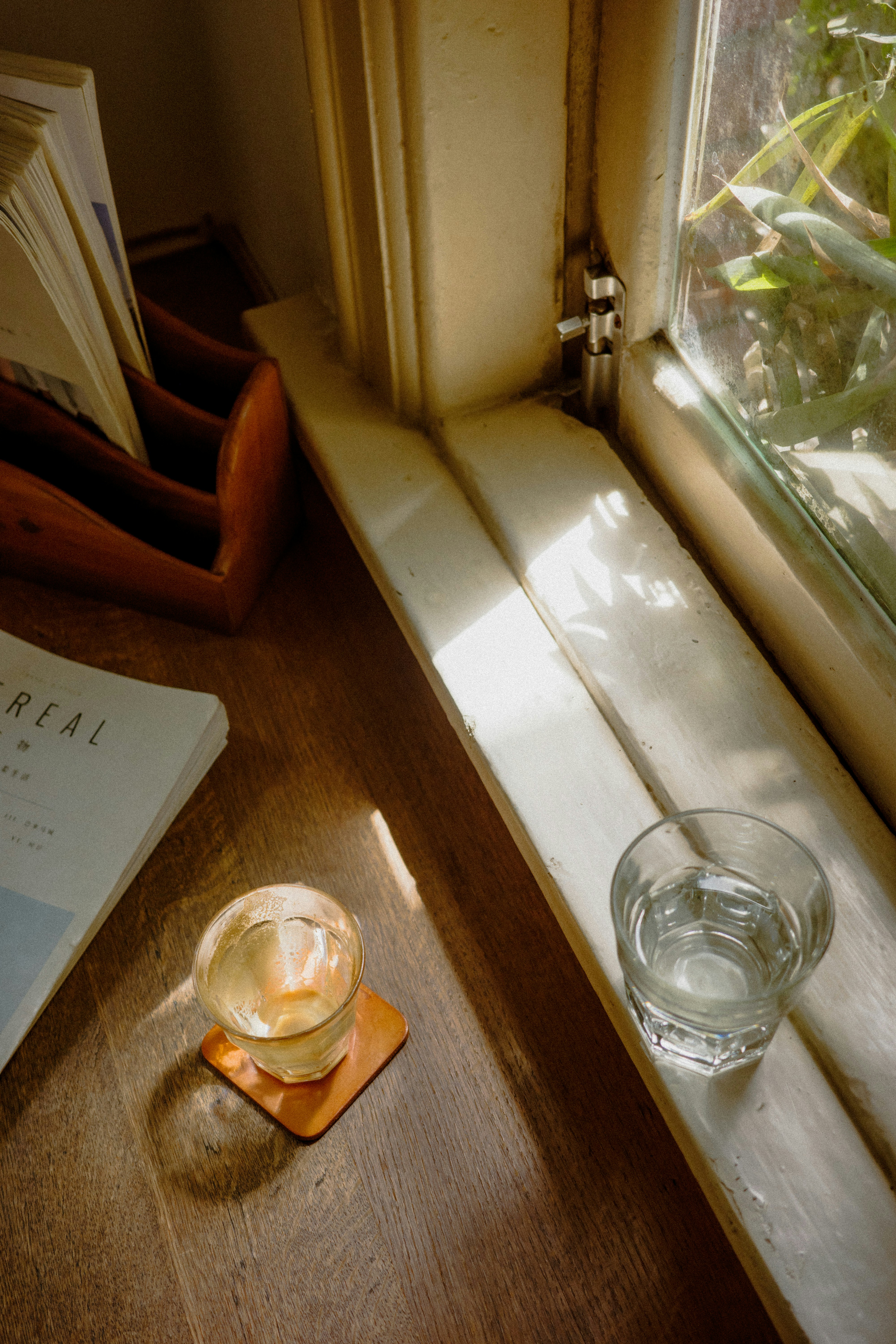Window Light and Quiet Desk: A Sunlit Moment with Glasses and Paper