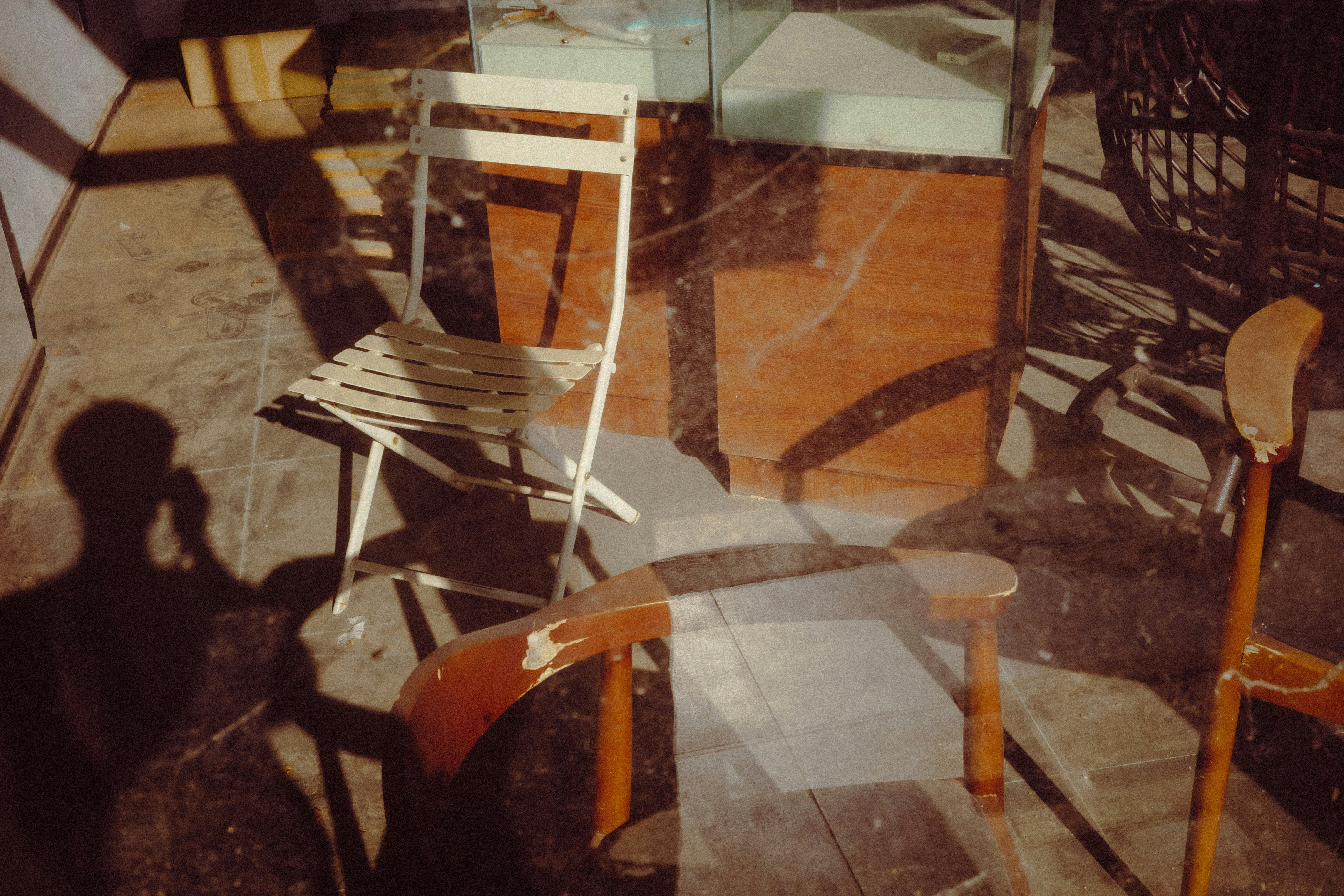 Shadows on a Sunlit Café: A Tilted Moment of Everyday Seating