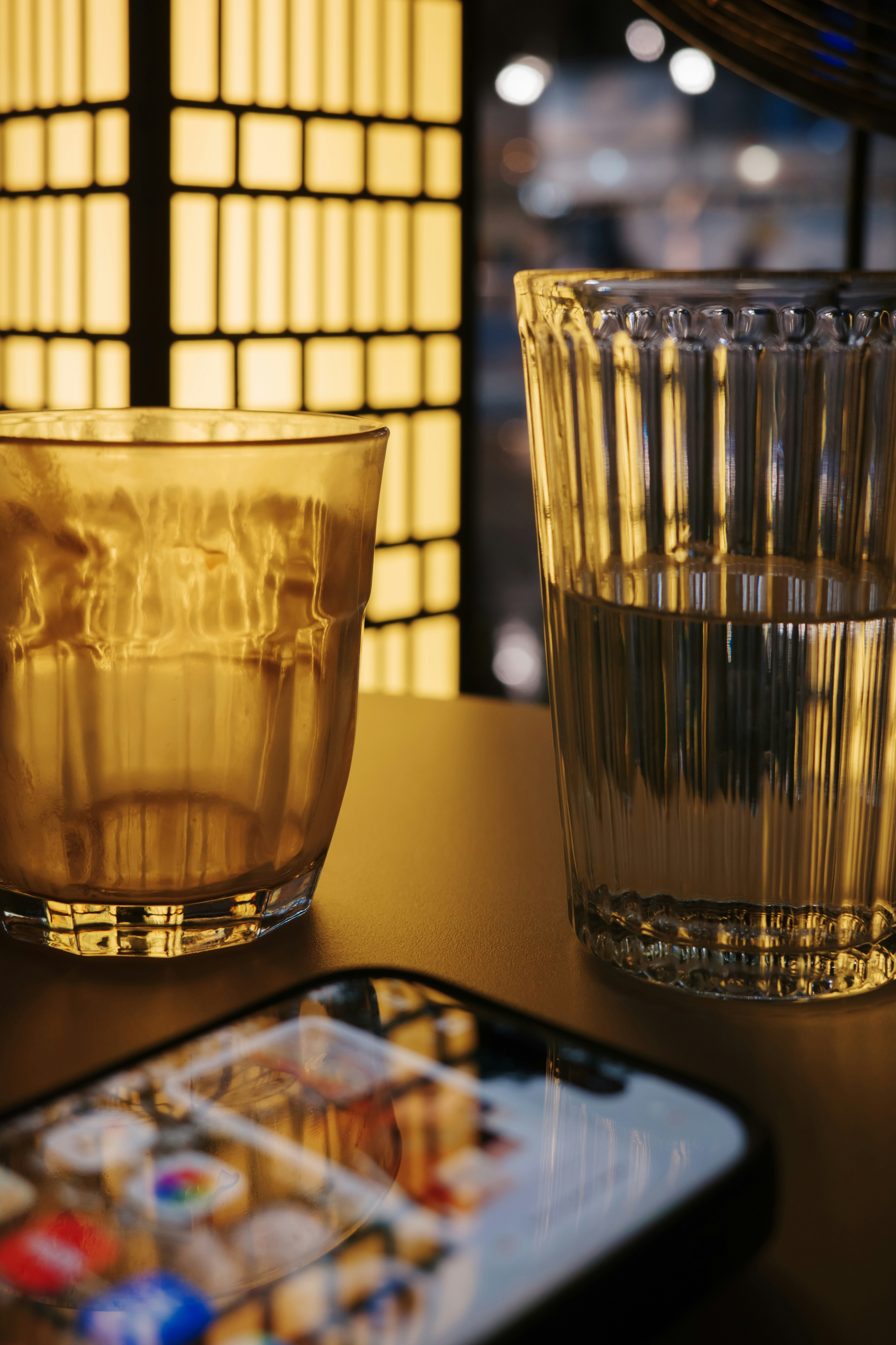 Two glasses and a smartphone on a table