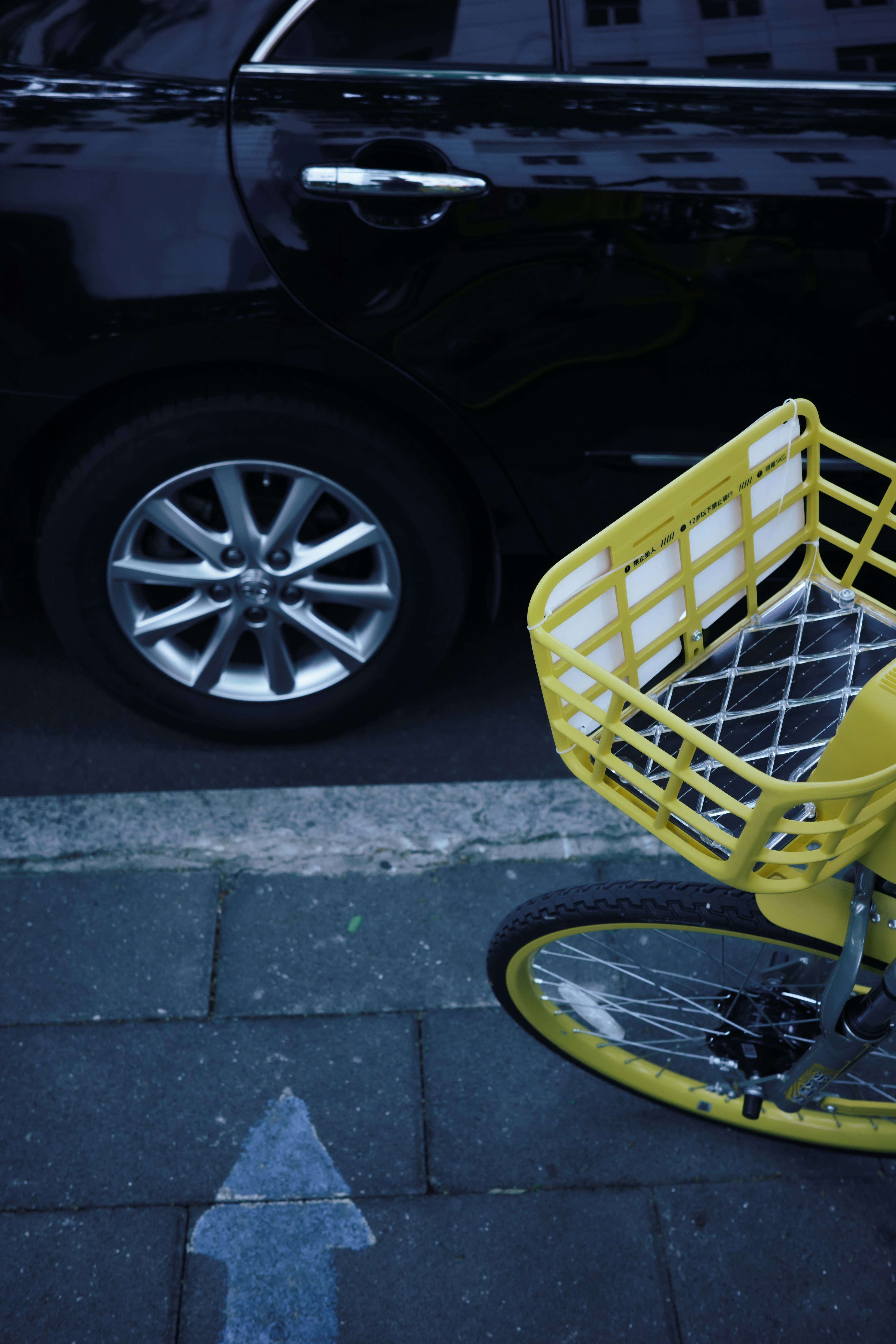 Yellow Basket, Black Car, and City Street: A Quiet Urban Moment