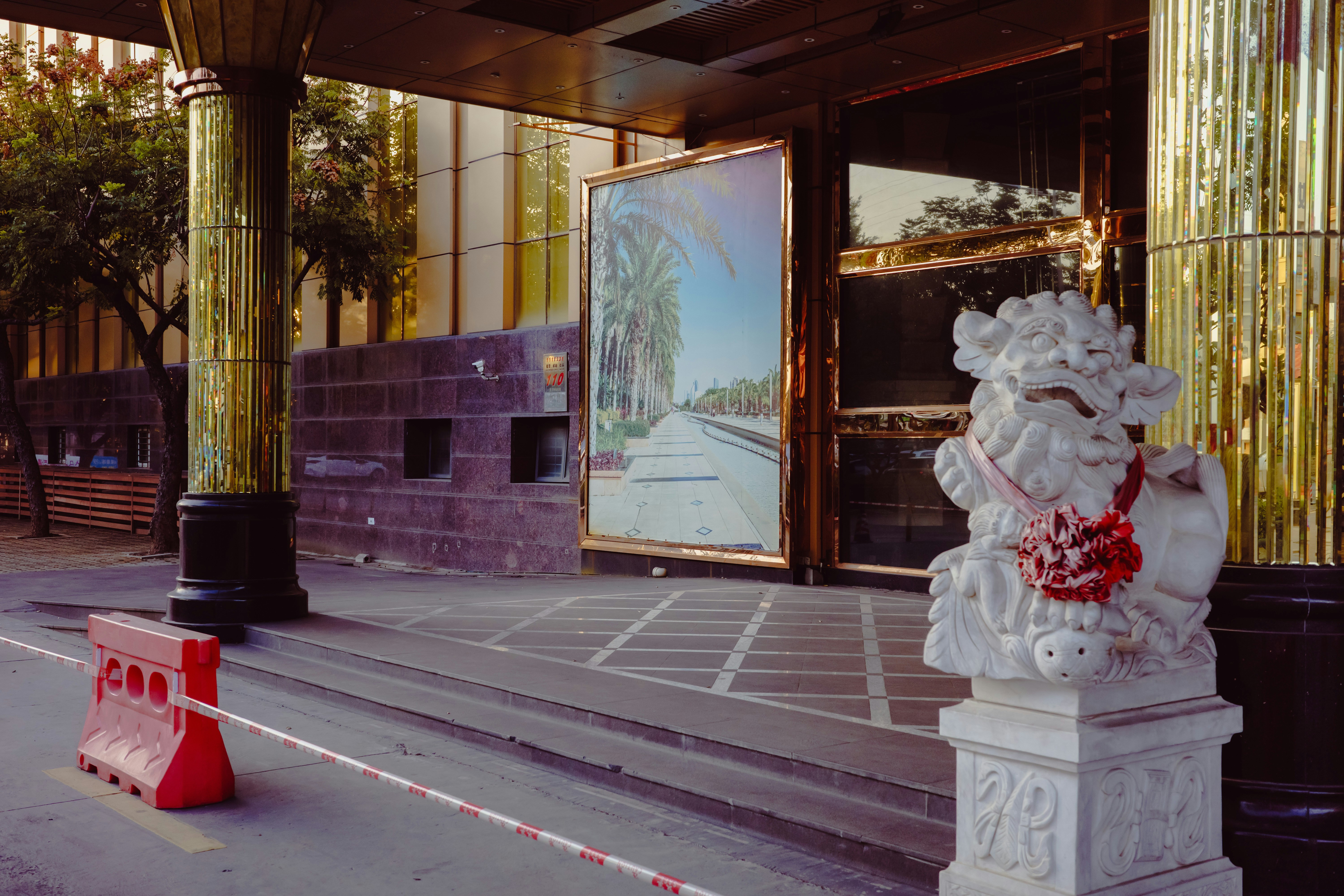 Golden-Bordered Entrance: A Quiet Street by a Luxuriant Facade