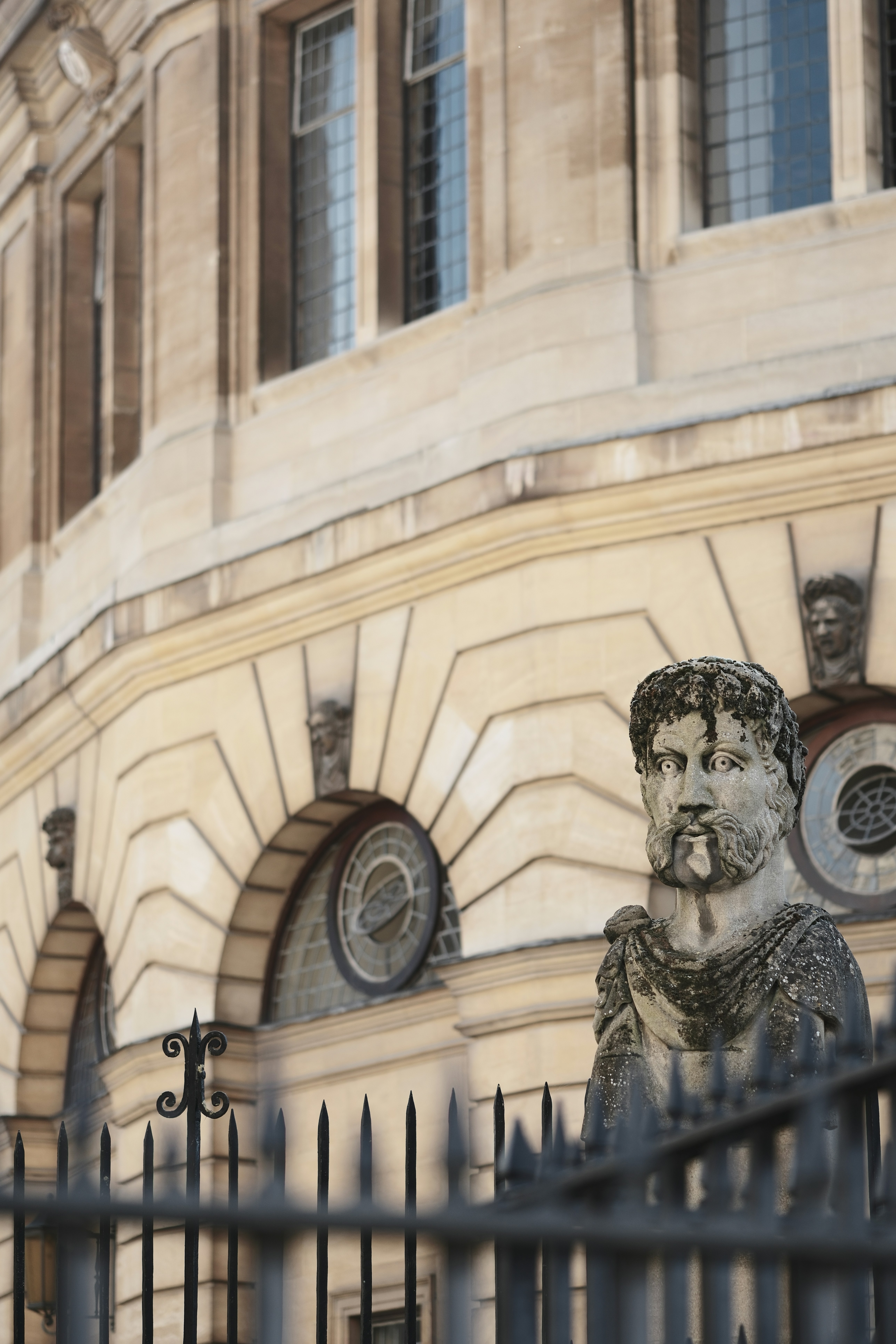 Weathered statue amid a grand stone facade