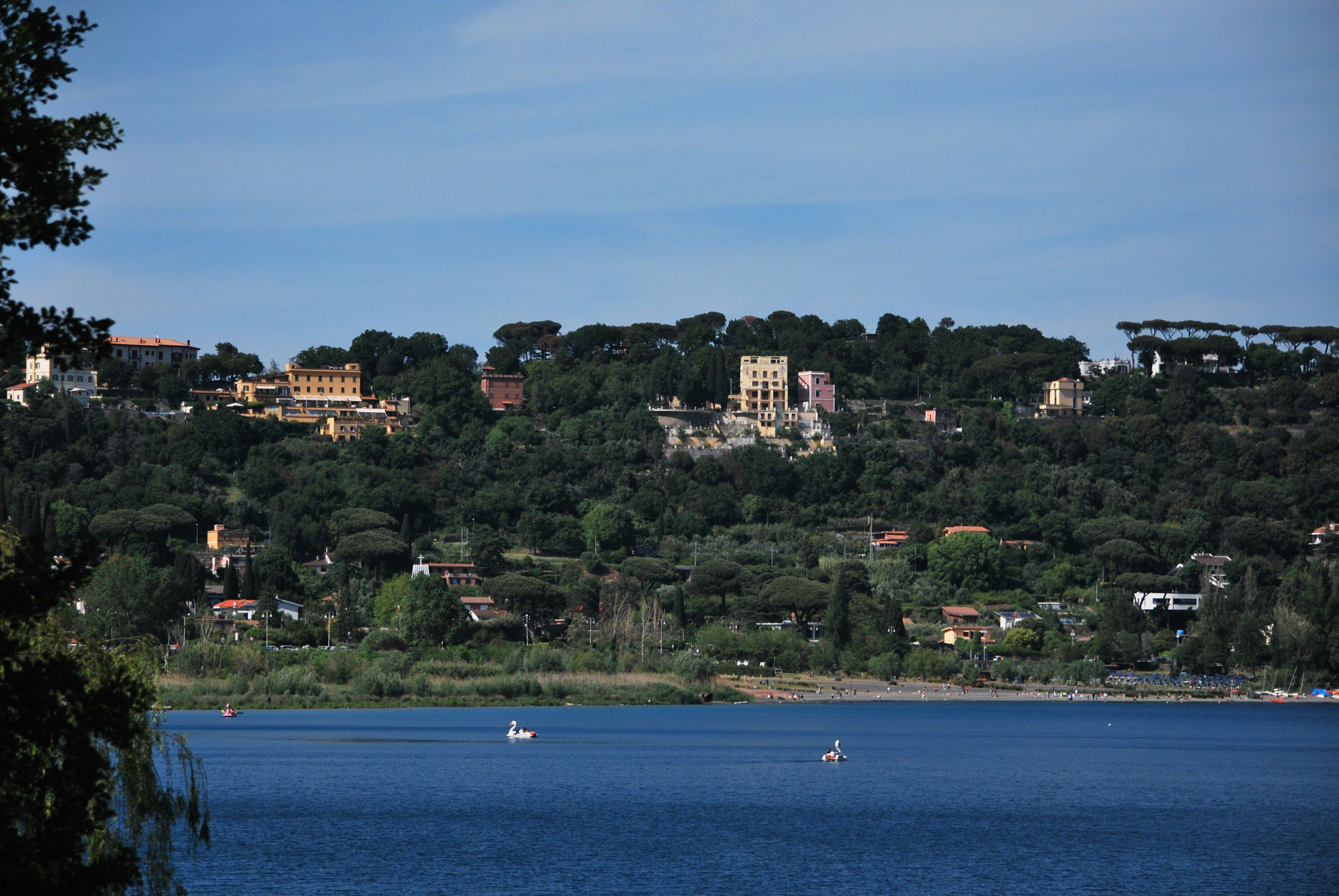 Lakeside villas perched above a coastal town
