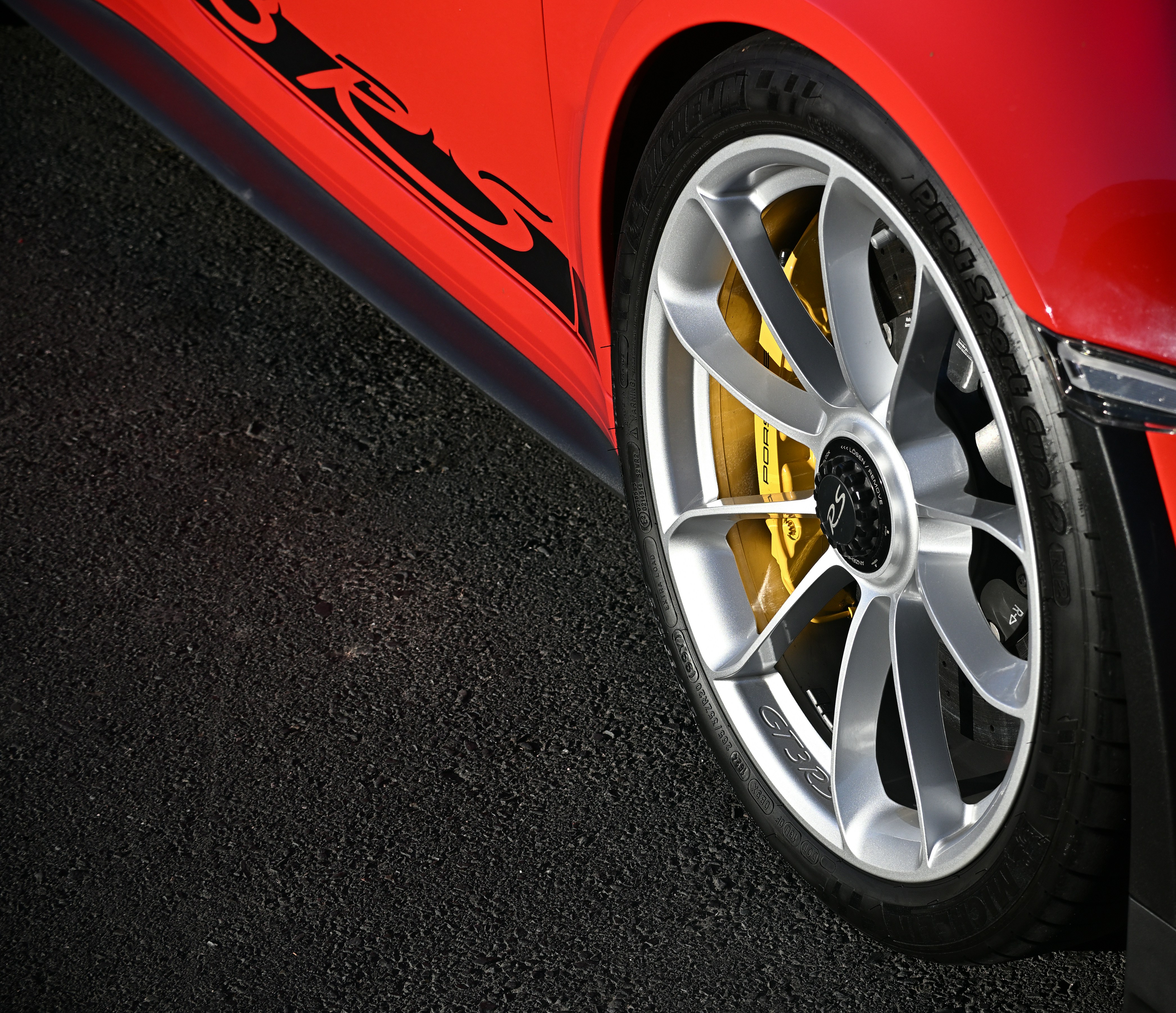 Silver turbine wheel meets red catwalk: a close-up of performance braking