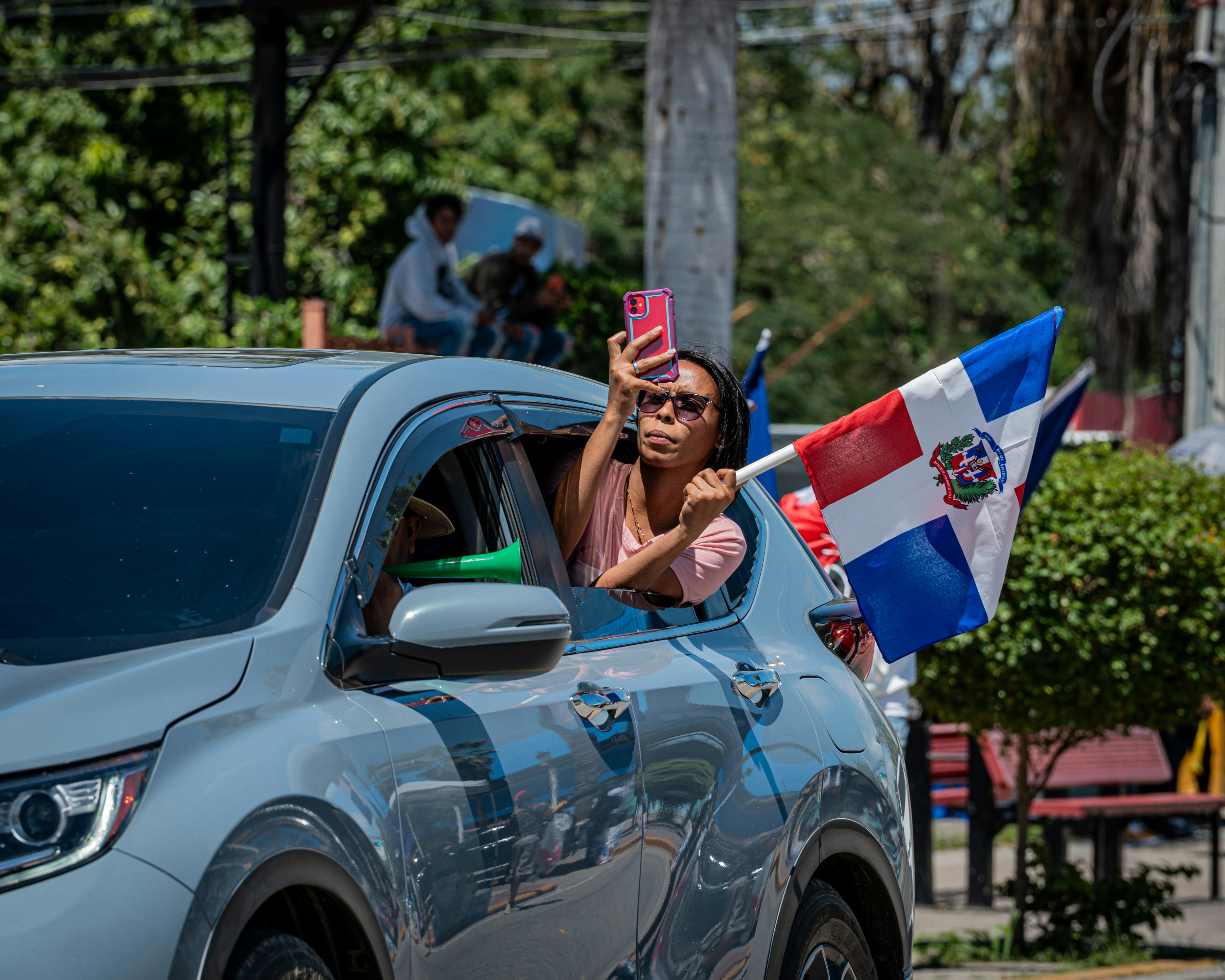Selfie in Transit: Dominican Flag Moments from a Moving Car