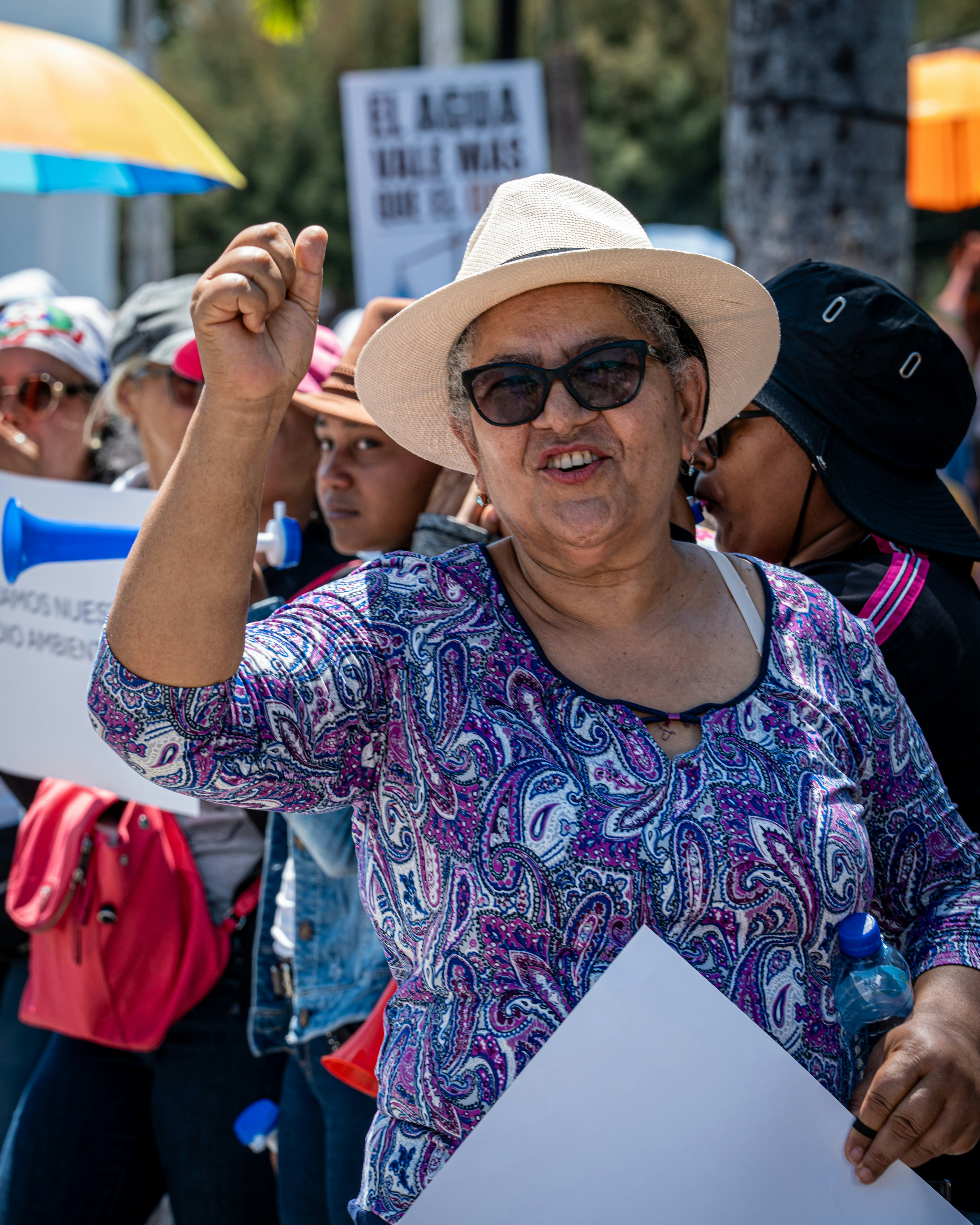 Woman in hat raises fist at protest