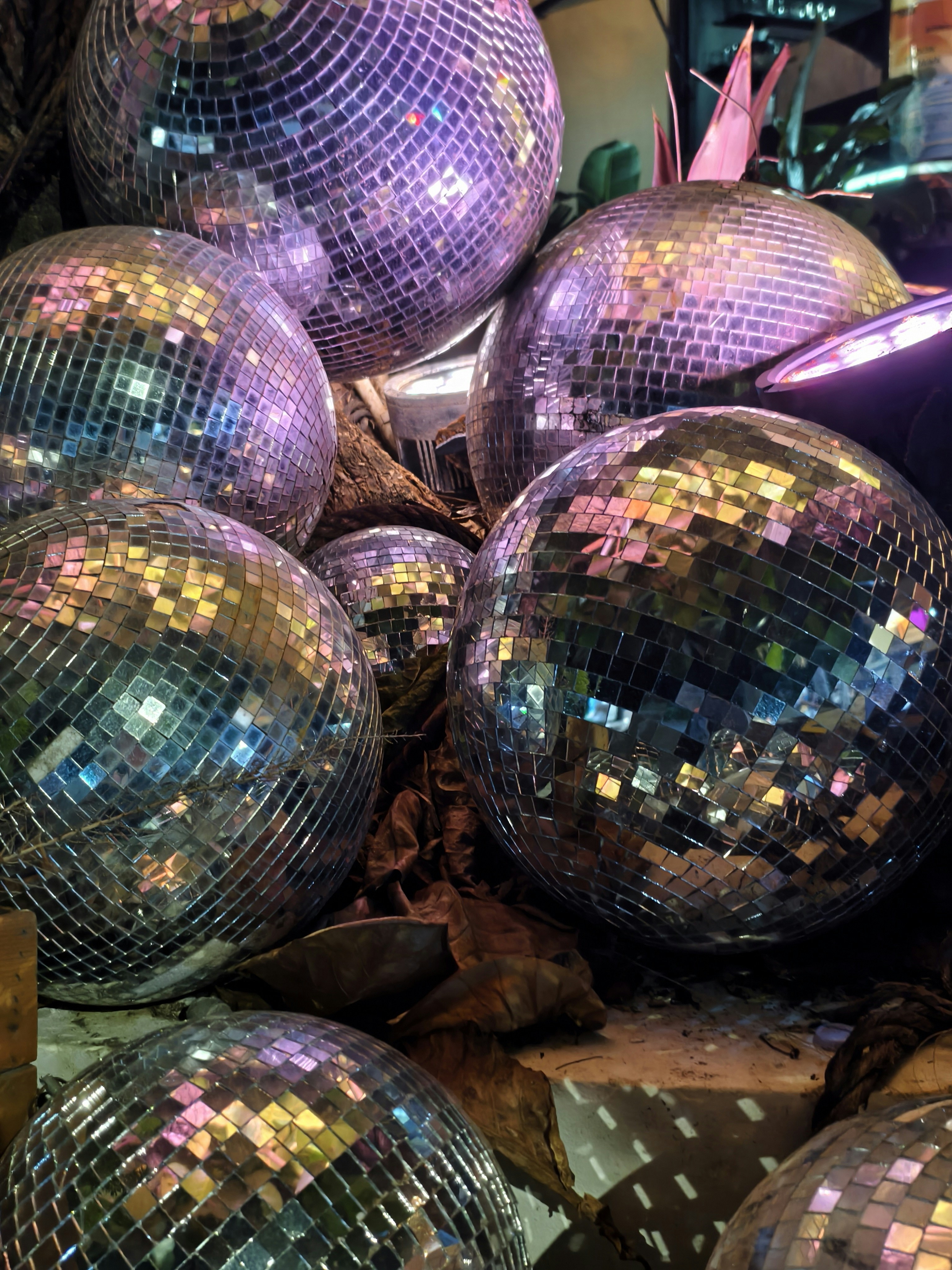 Chromatic Orbs: A Gallery of Disco Balls Nestled in Colorful Light