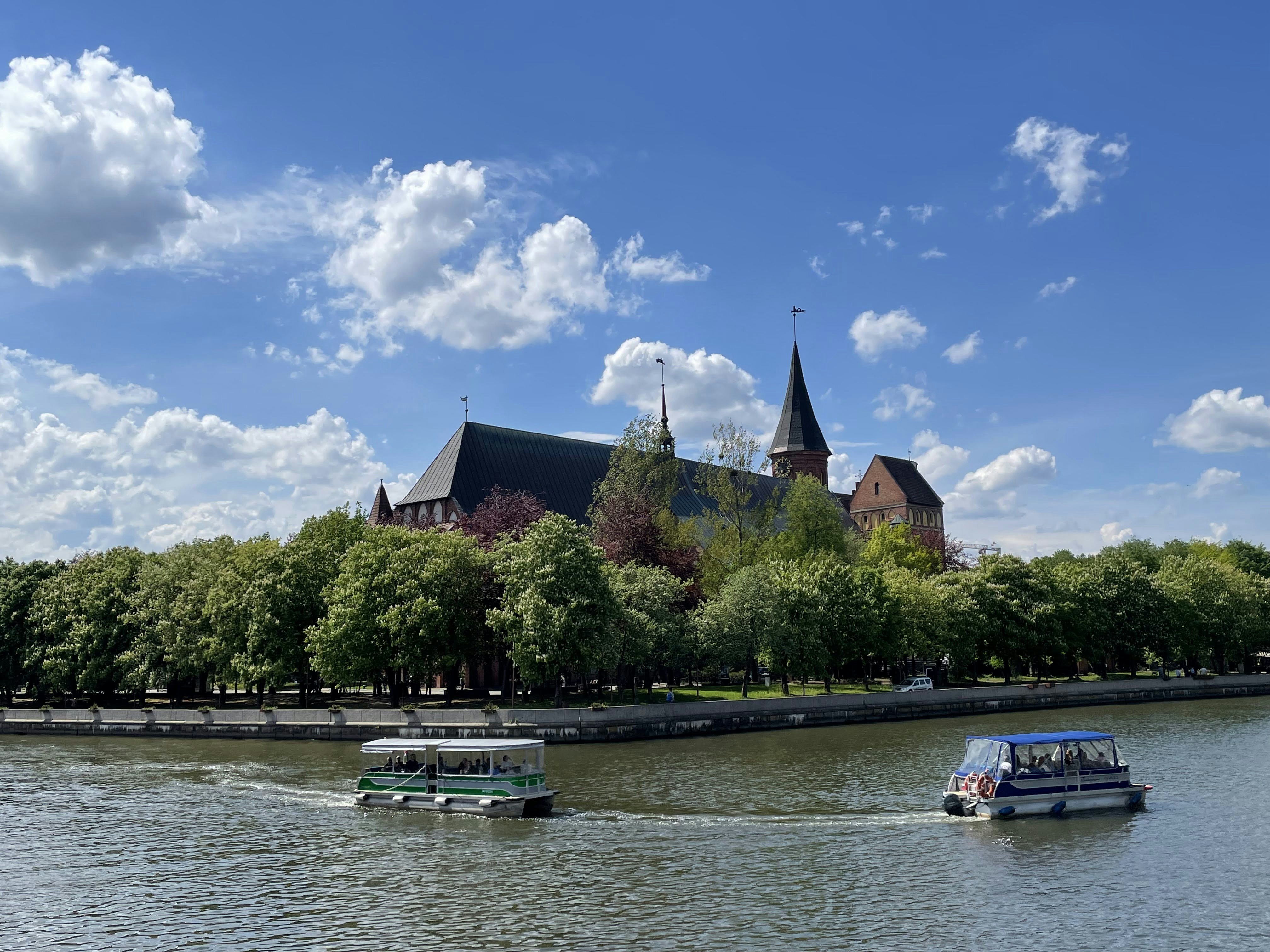 Cityscape by the Rhein: Boats Drift Past a Riverside Abbey