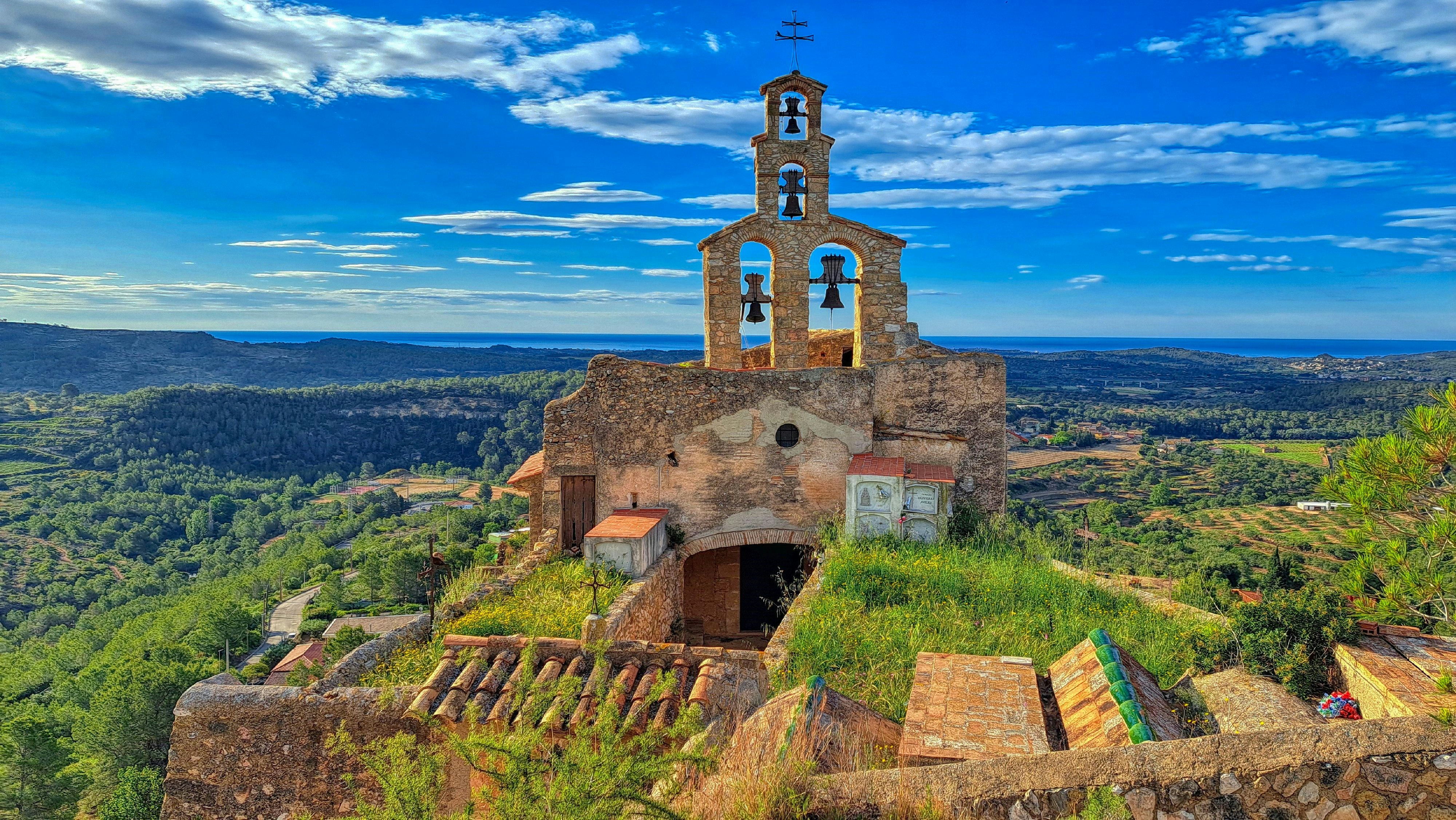 Ruined Bell Tower over a sunlit Tuscan-like Landscape