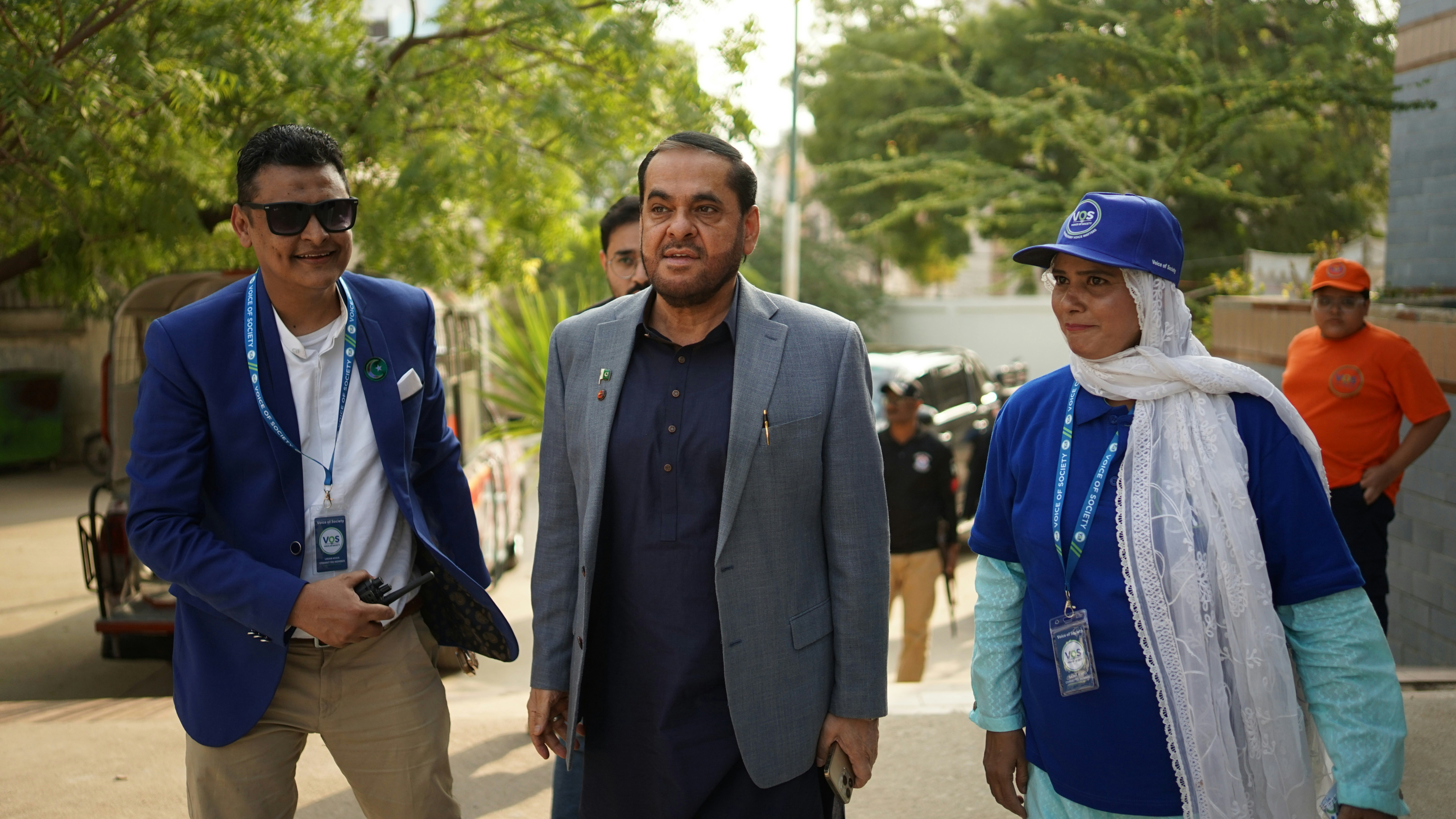 A Triad of Confidence: Presidential Aides Walk Through a Sunlit Campus