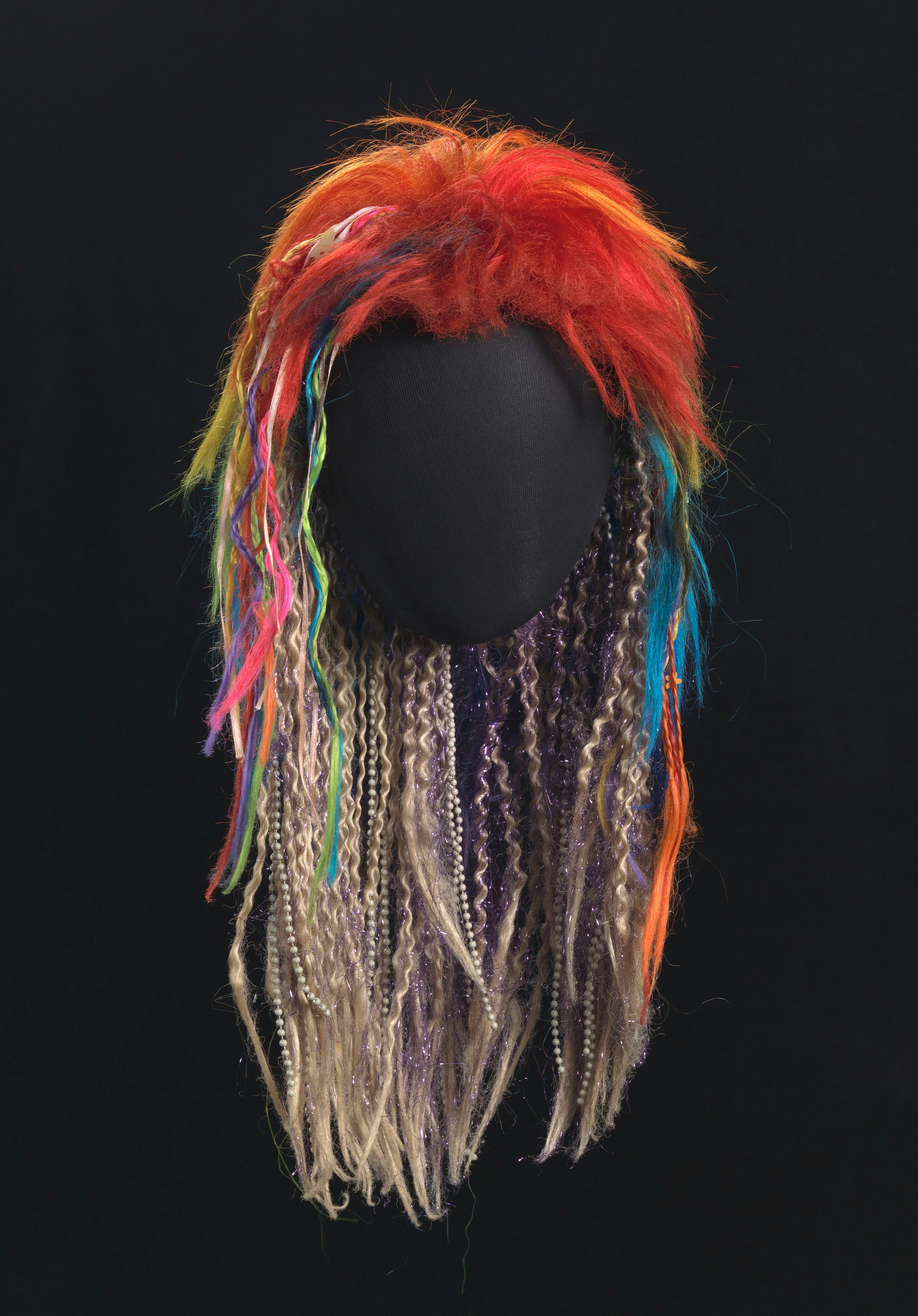 Rainbow-Mildred: A Multicolor Fringe Wig on a Black Silhouette Head