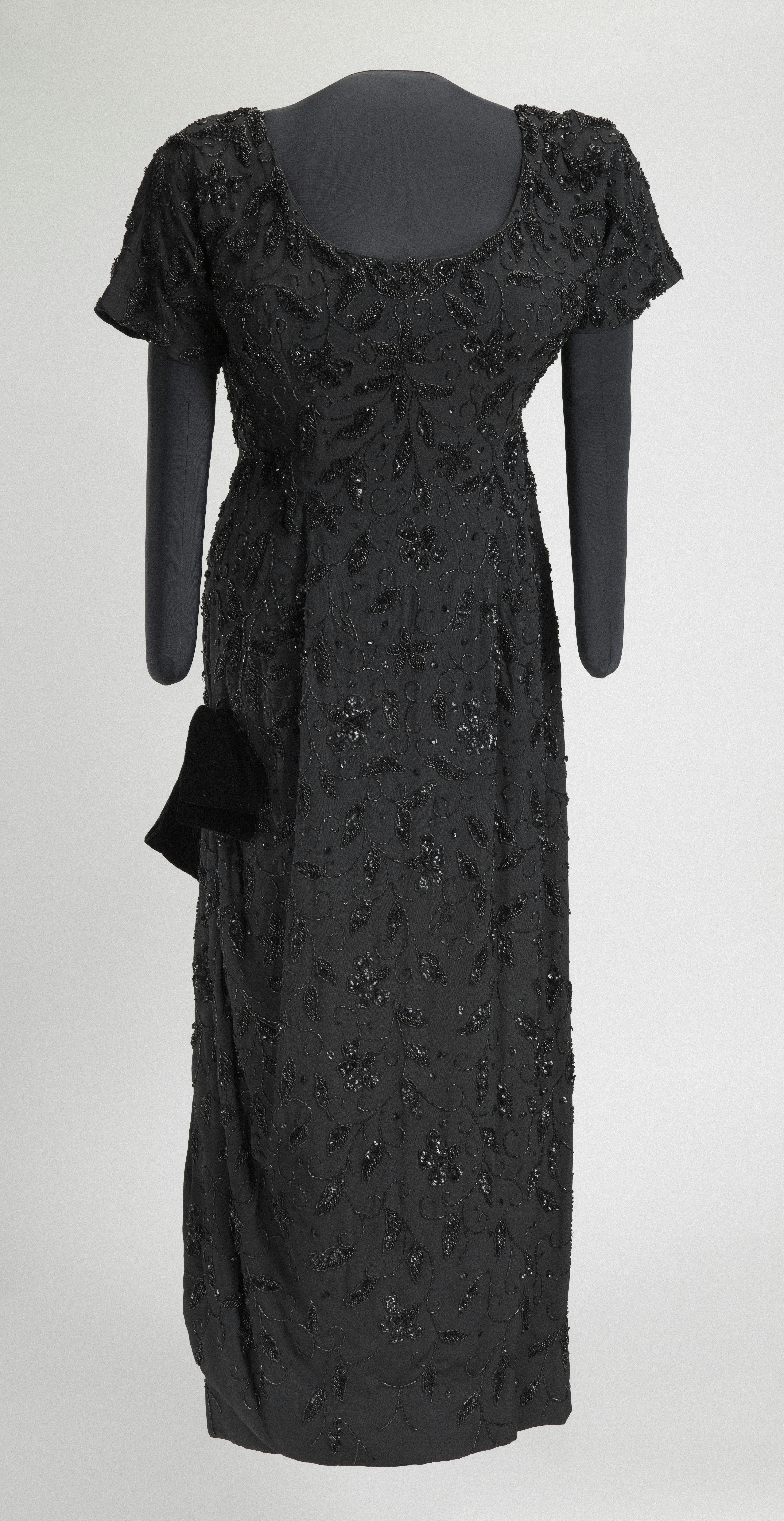 Midnight Beaded Gown on a Stand: Elegance in Noir Textures