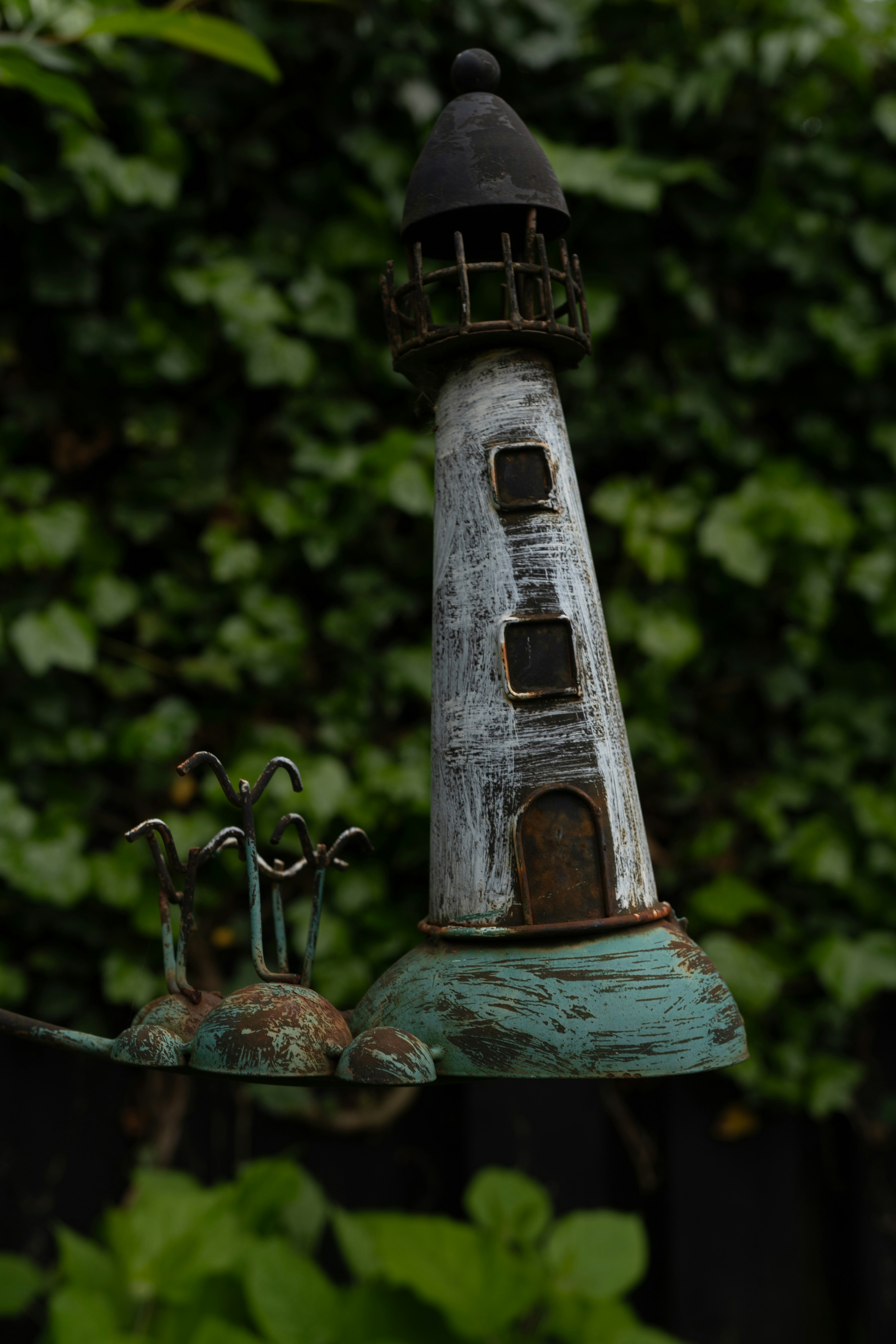 Whimsical Lighthouse on Rusted Pedestals in a Verdant Wake