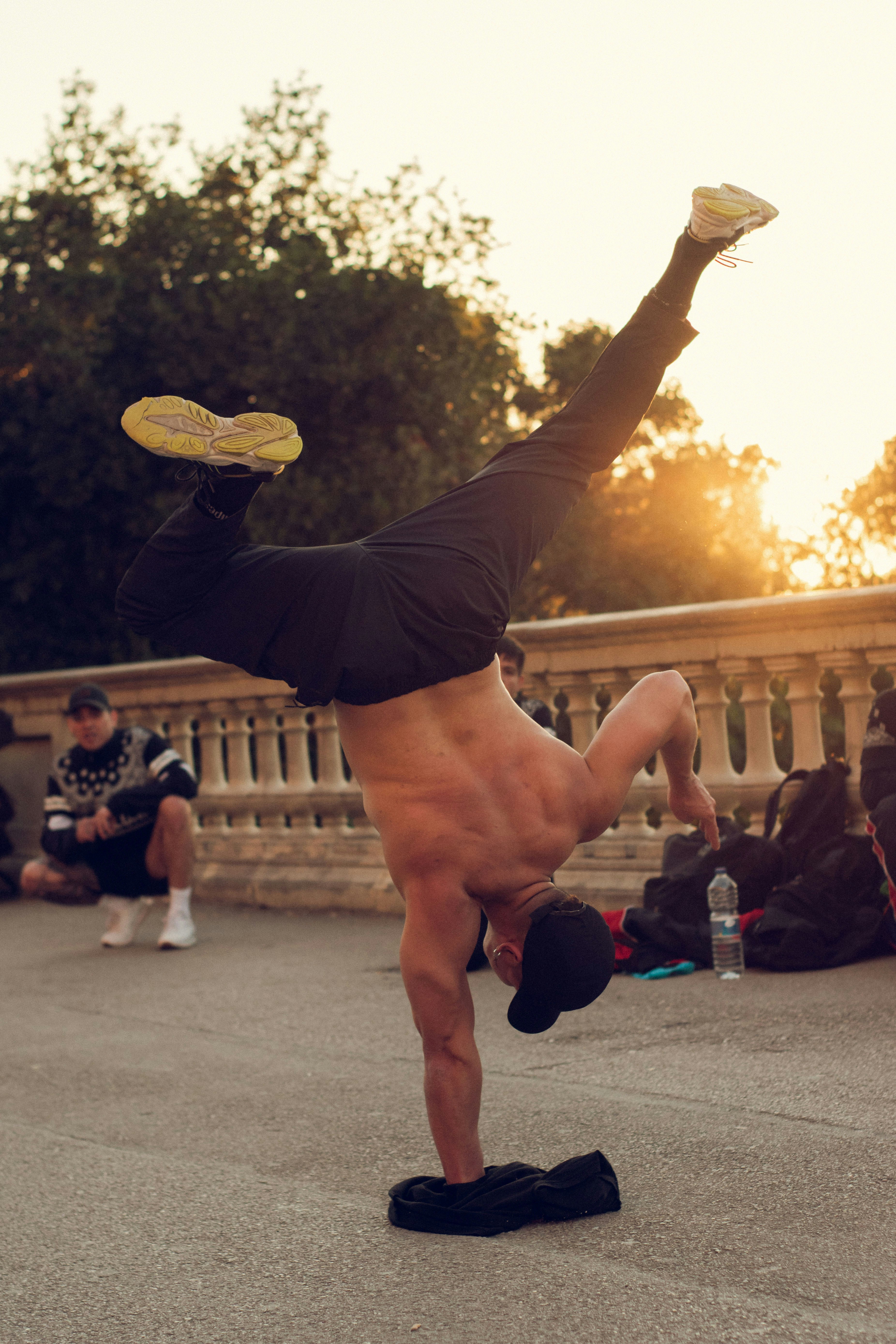 Balance in Sunset: A Breakdancer Defies Gravity on the Promenade