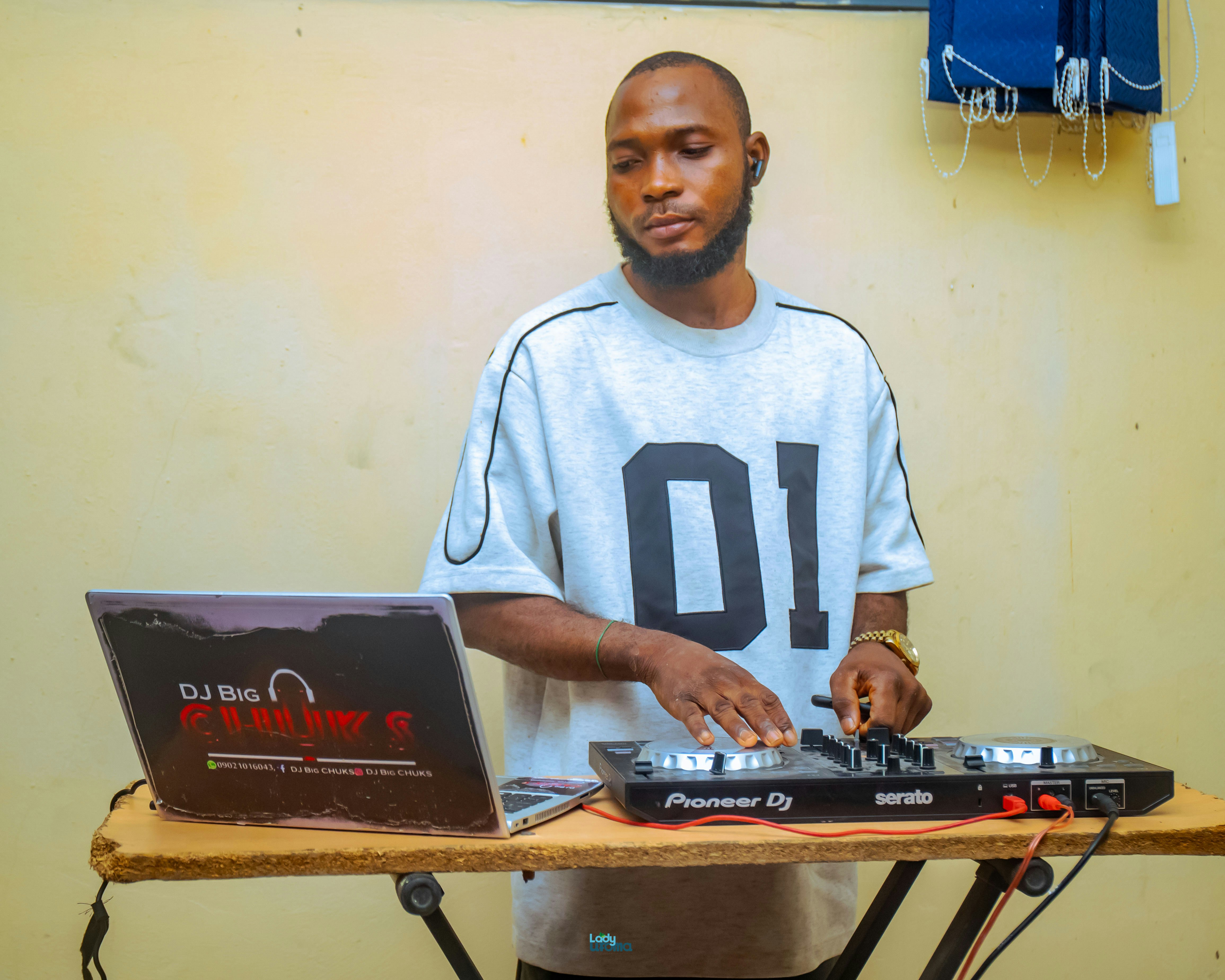DJ in the Studio: Focused Beatmaker at a Makeshift Table