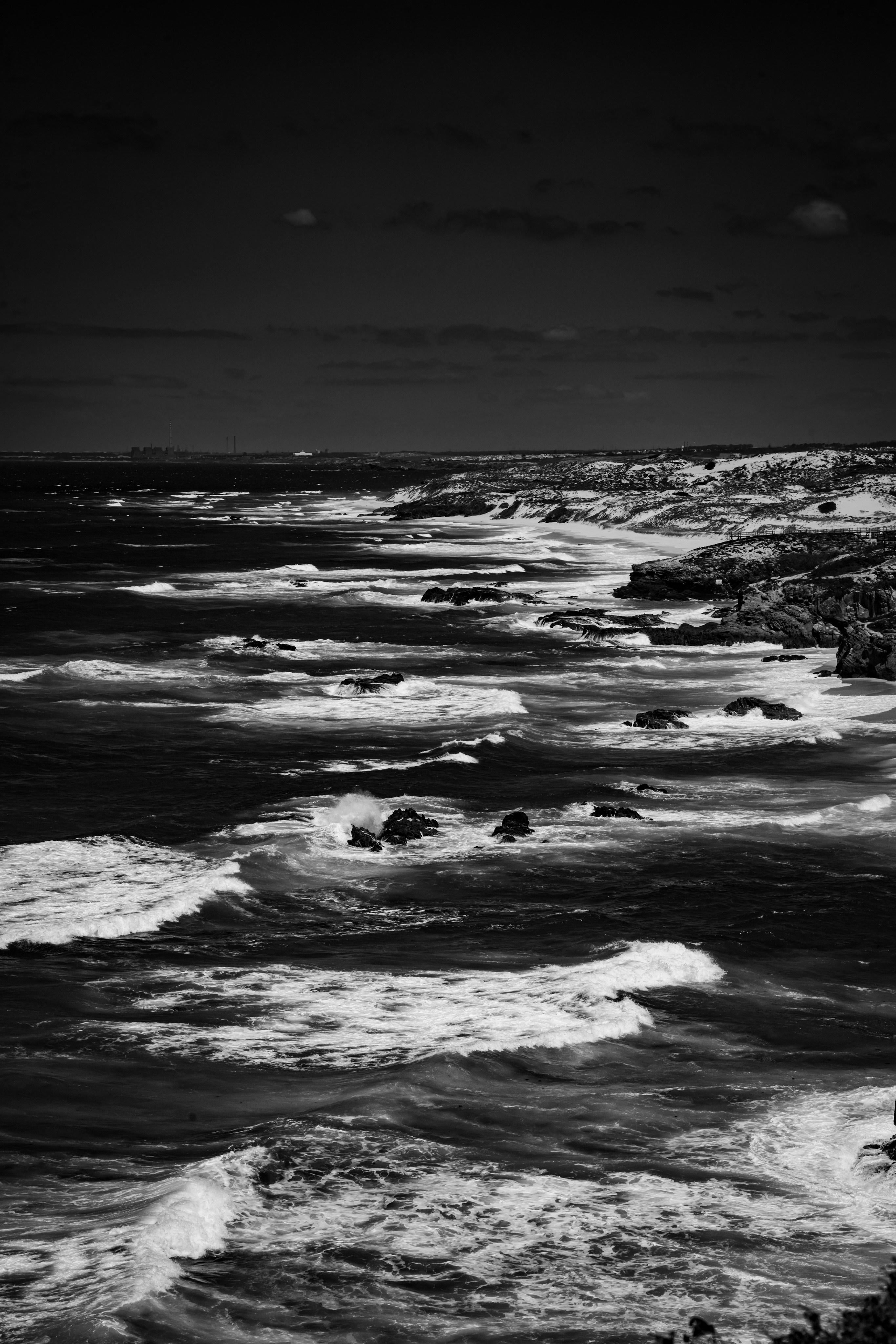 Monochrome Sea Reach: Waves Advancing Along a Wind-Swept Shore