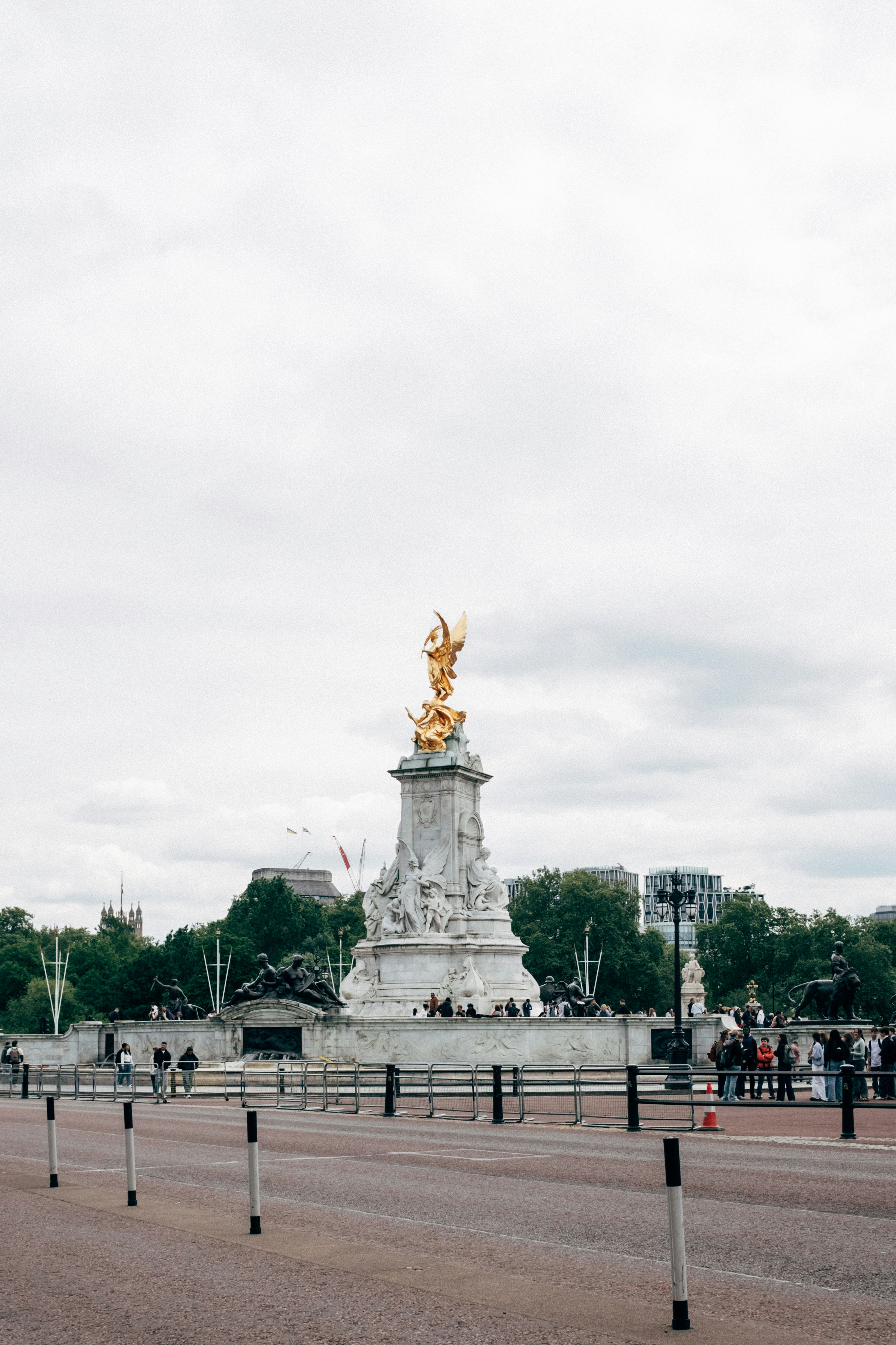 Golden Statue on a Marble Plinth Amid a City Square