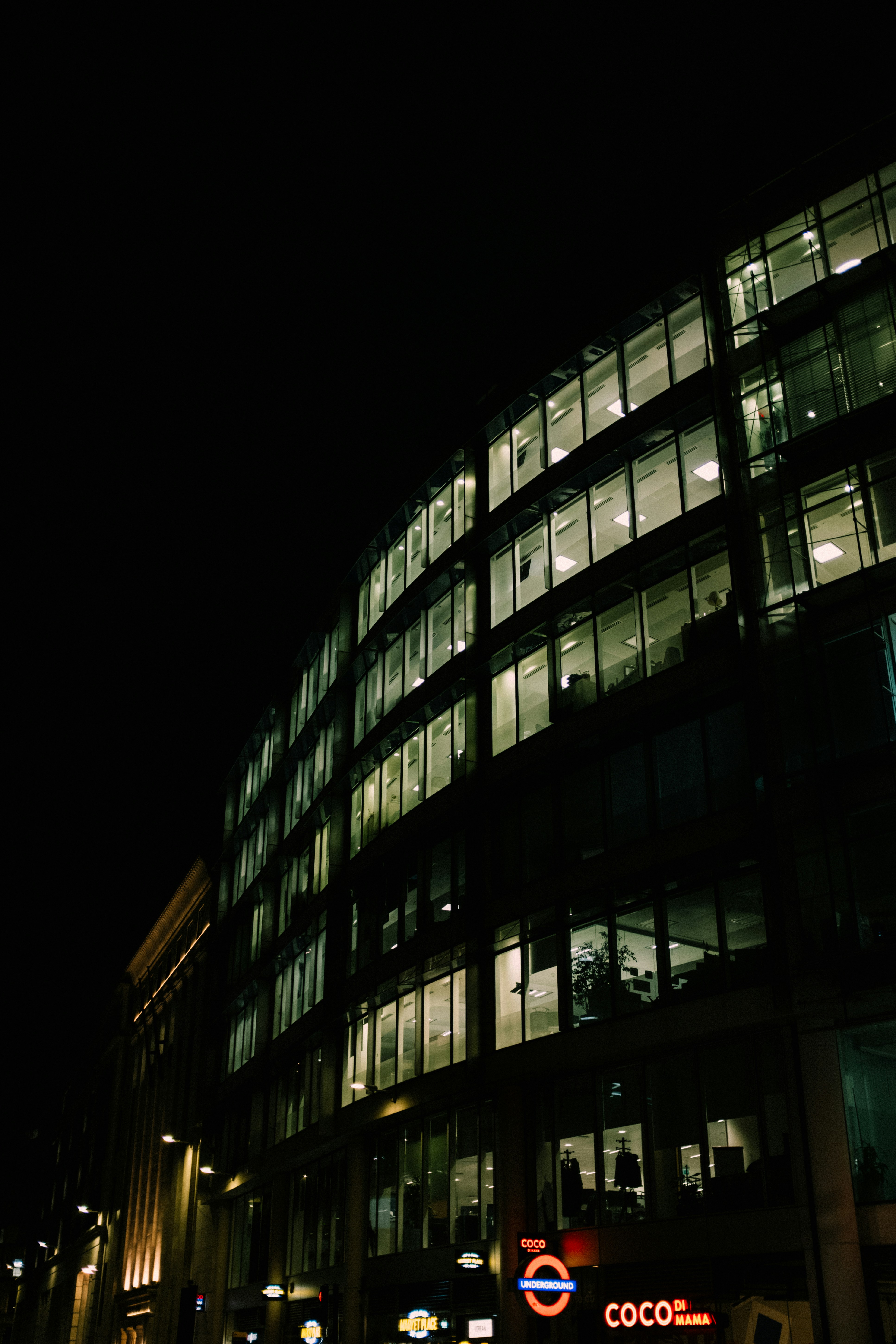 Urban Glass: Nighttime Office Facade Illuminates the City