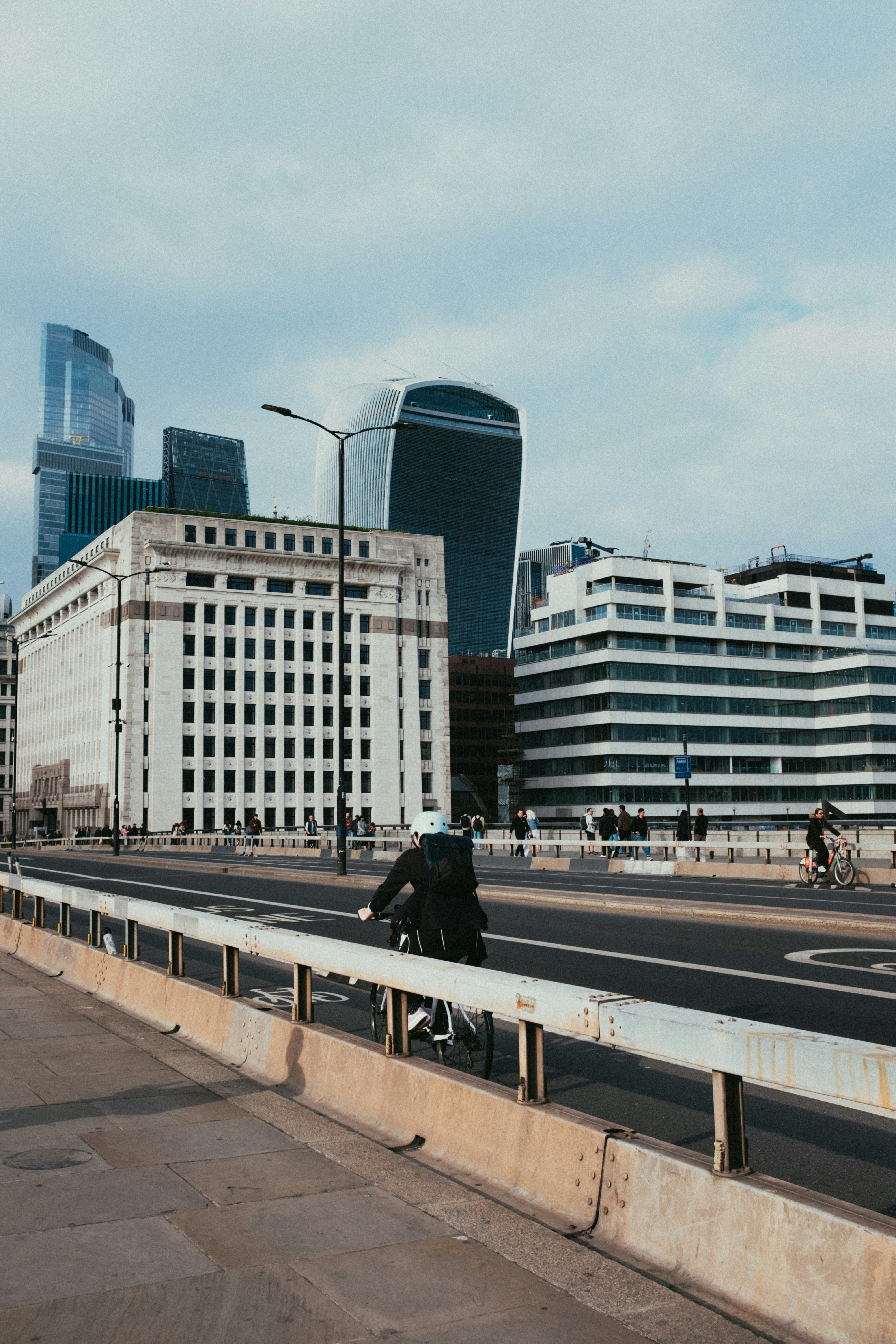 City Rhythm on the Bridge: A Cyclist and Skyscrapers