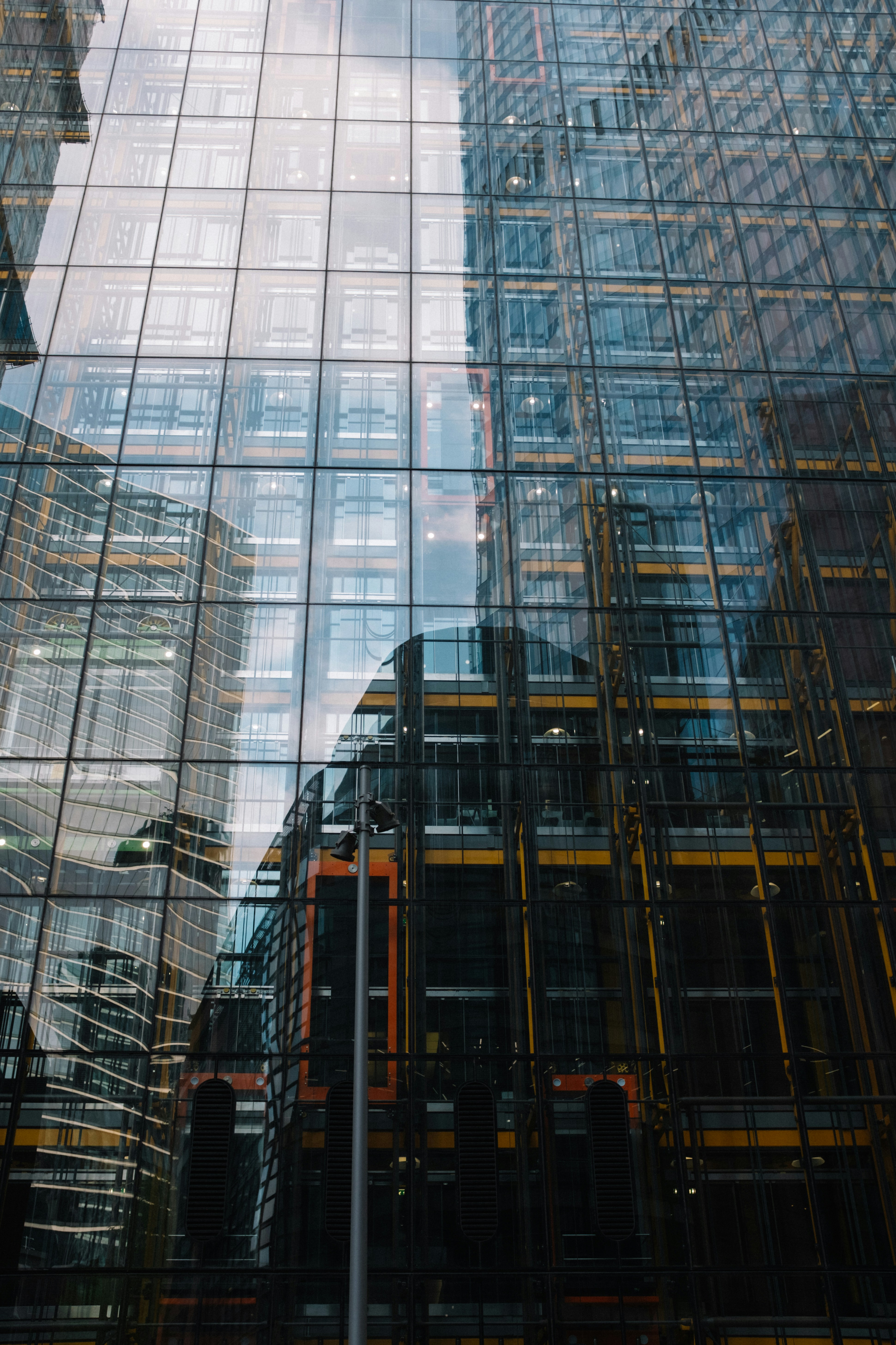 Reflections in Glass: A Cityscape Rippling Across a Faceted Facade