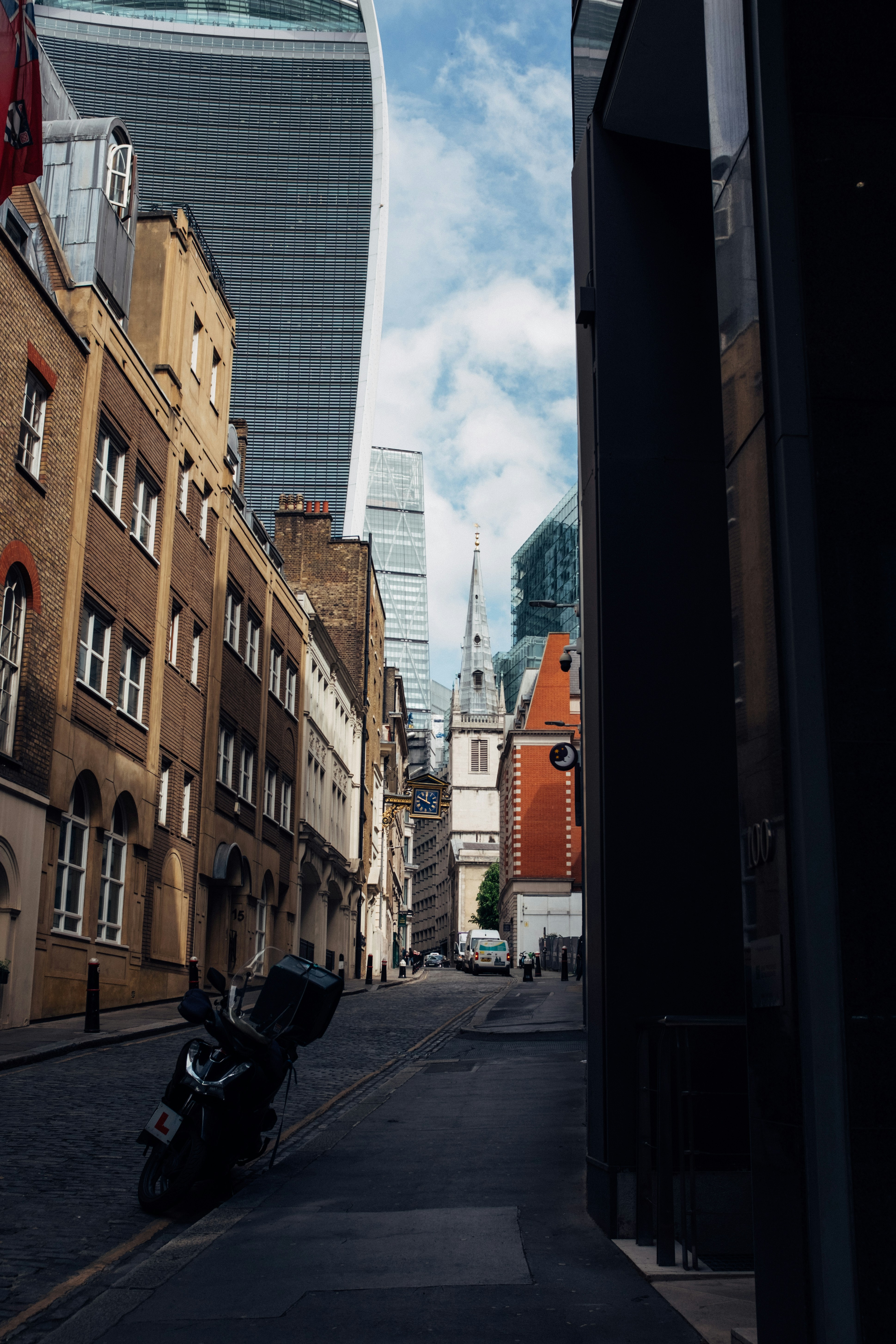 Urban Ascent: A Narrow Street Between Glass Giants