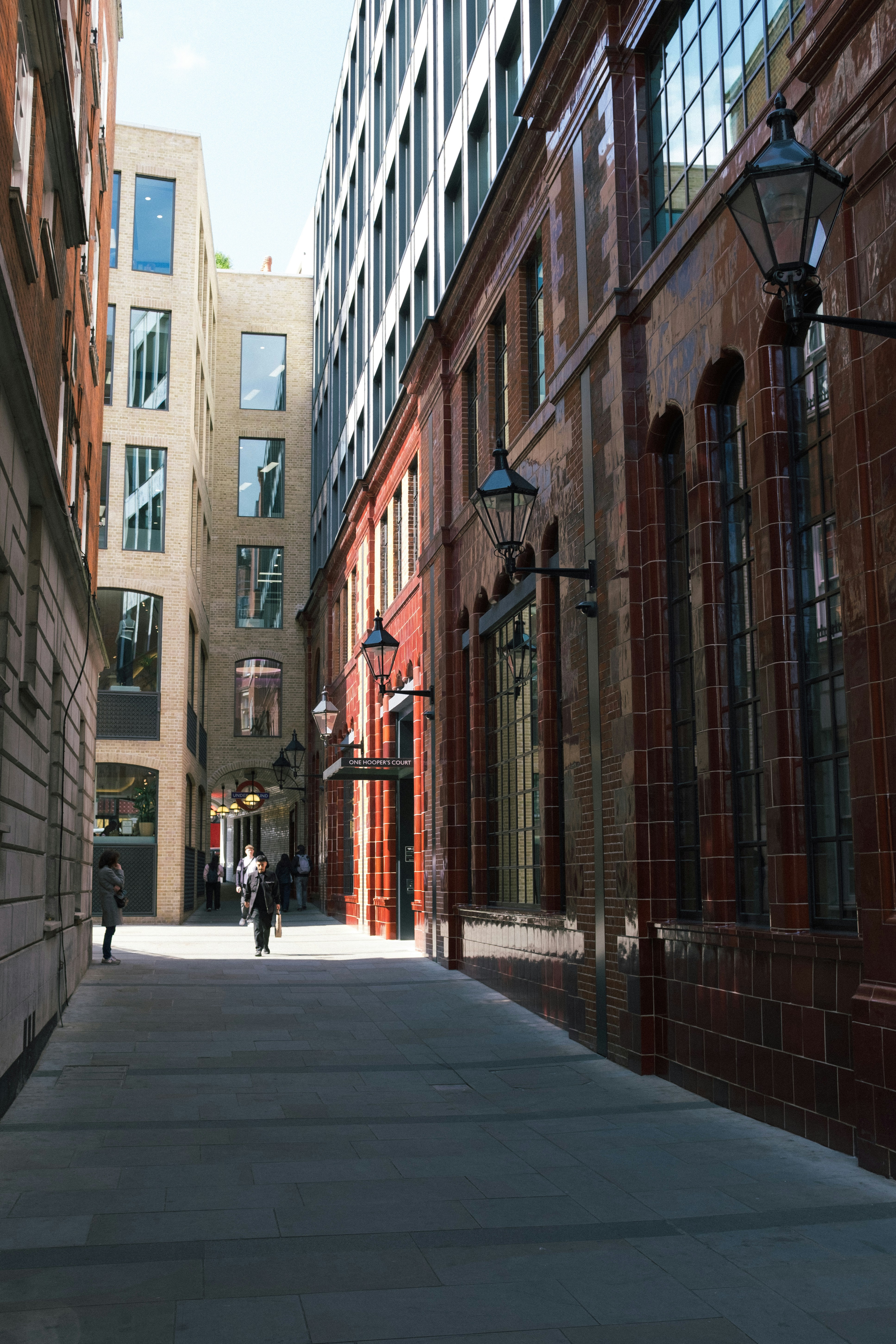 Sunlit Alleyway Between Brick Facades