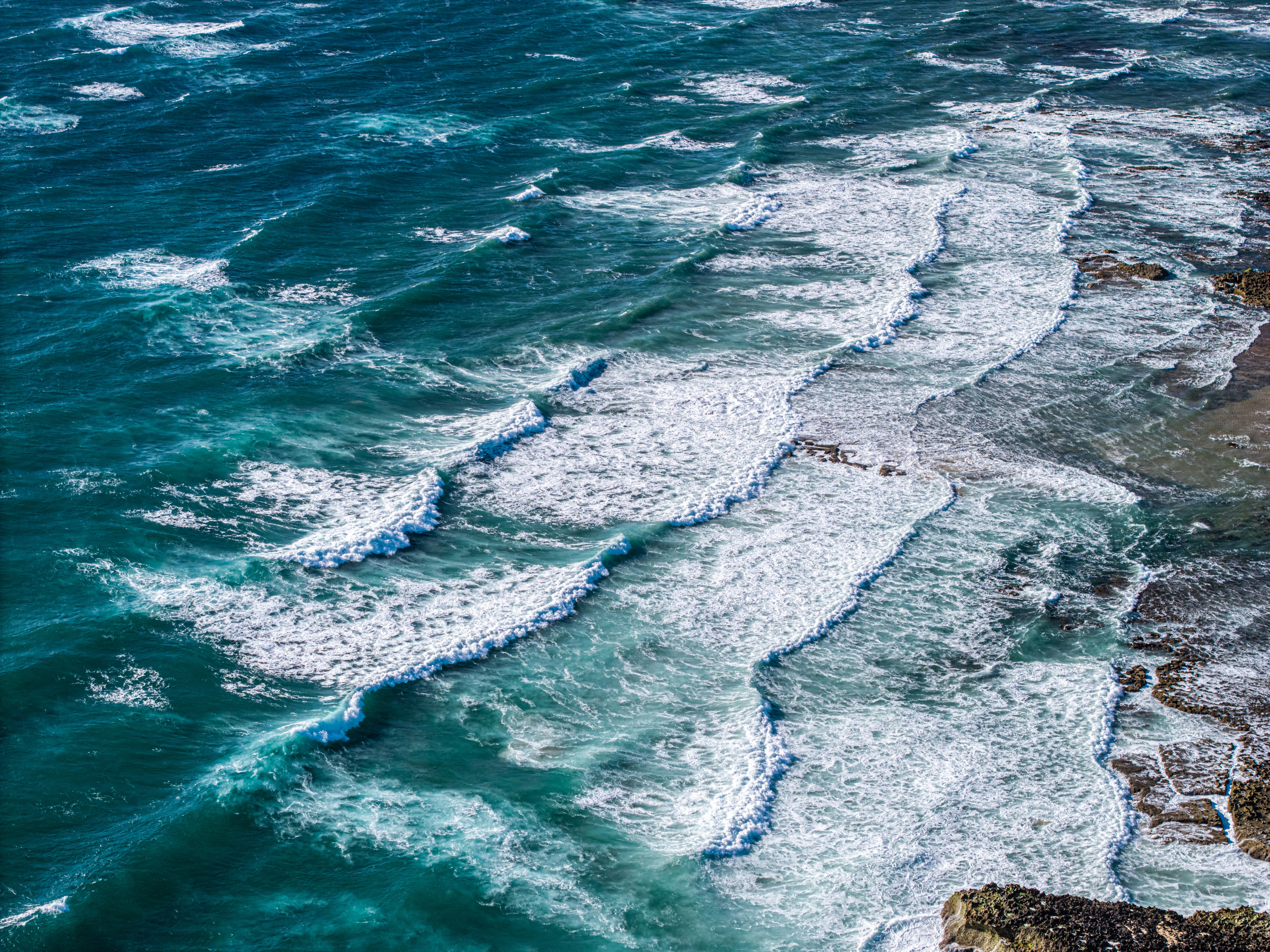 Rhythmic Shorelines: Aerial View of Untamed Ocean Crescents