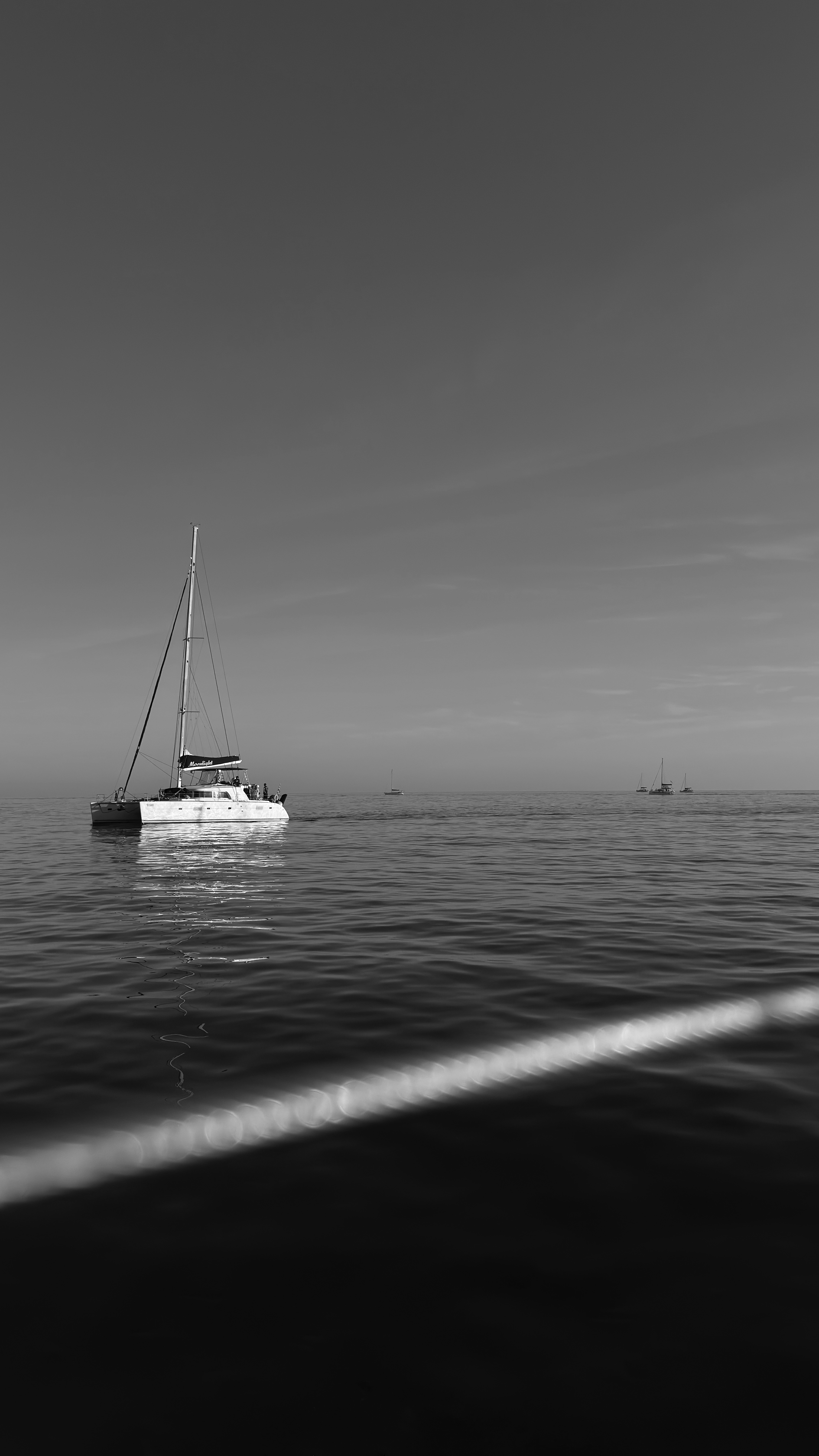 Sailing Vessel at Dusk: A Quiet Horizon over Calm Seas