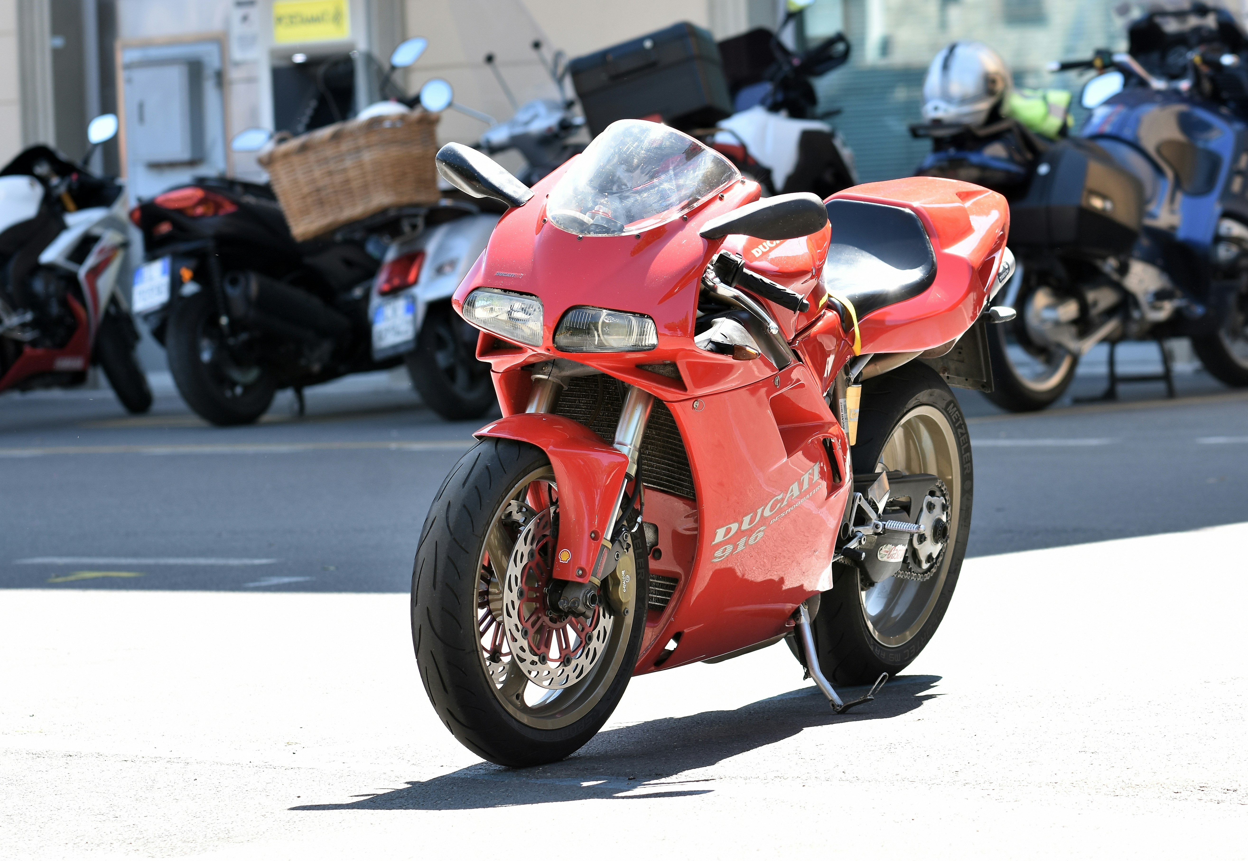Red Ducati Stands Out in a Busy Street, Ready for the Open Road