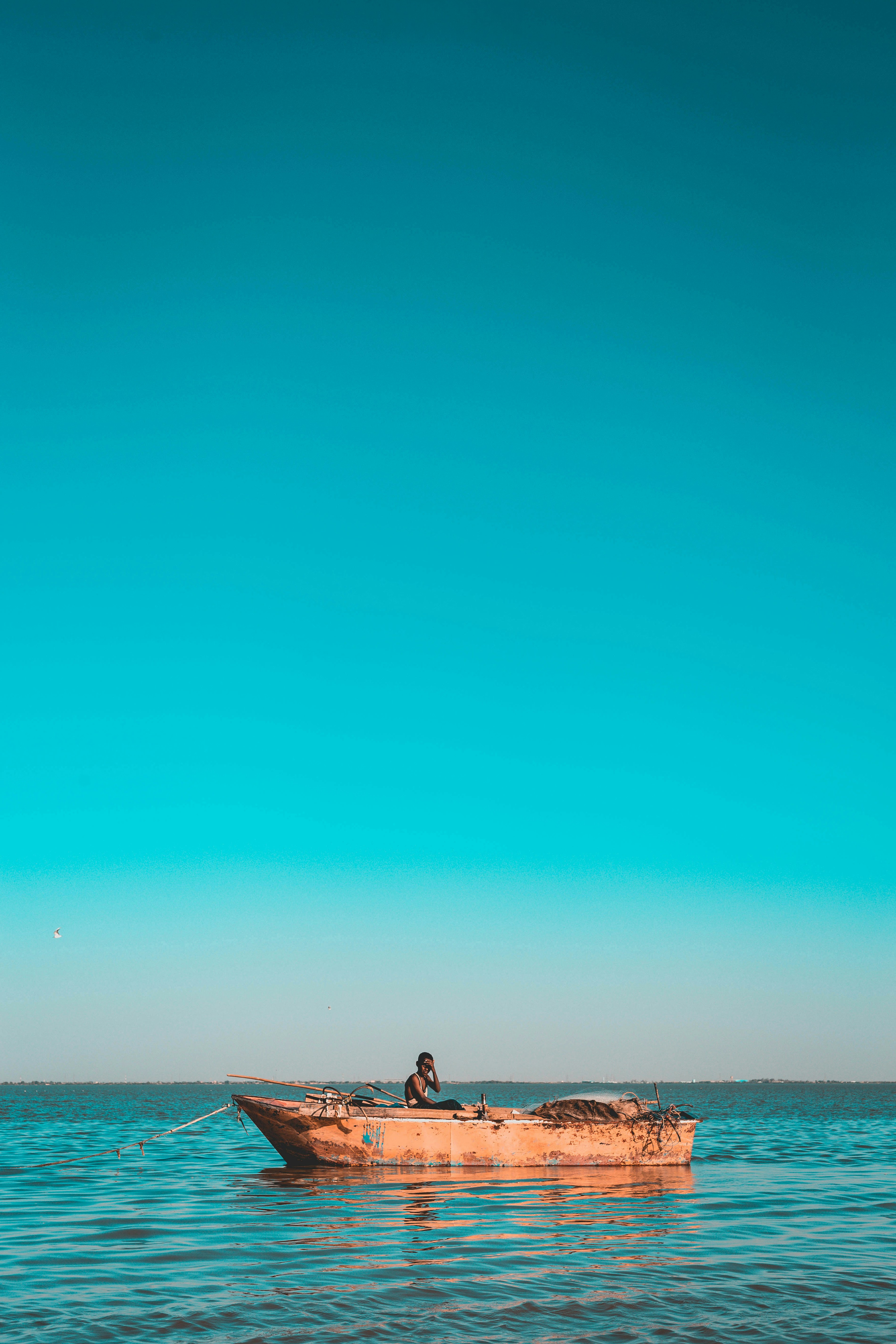 Solitary Boat at Dusk: A Quiet Moment on the Calm Sea