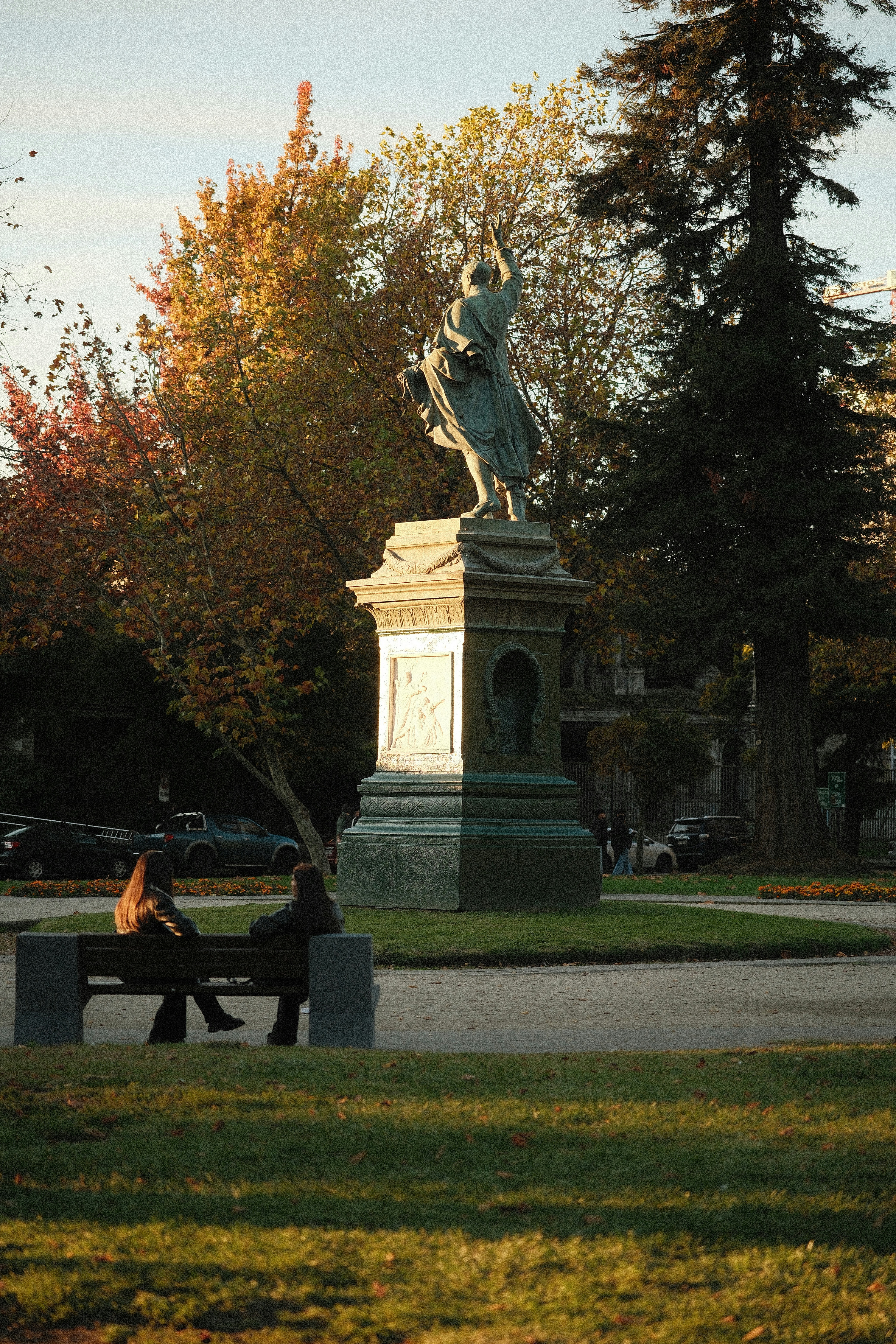 Statue in Autumn Park: A Quiet Moment by the Bench