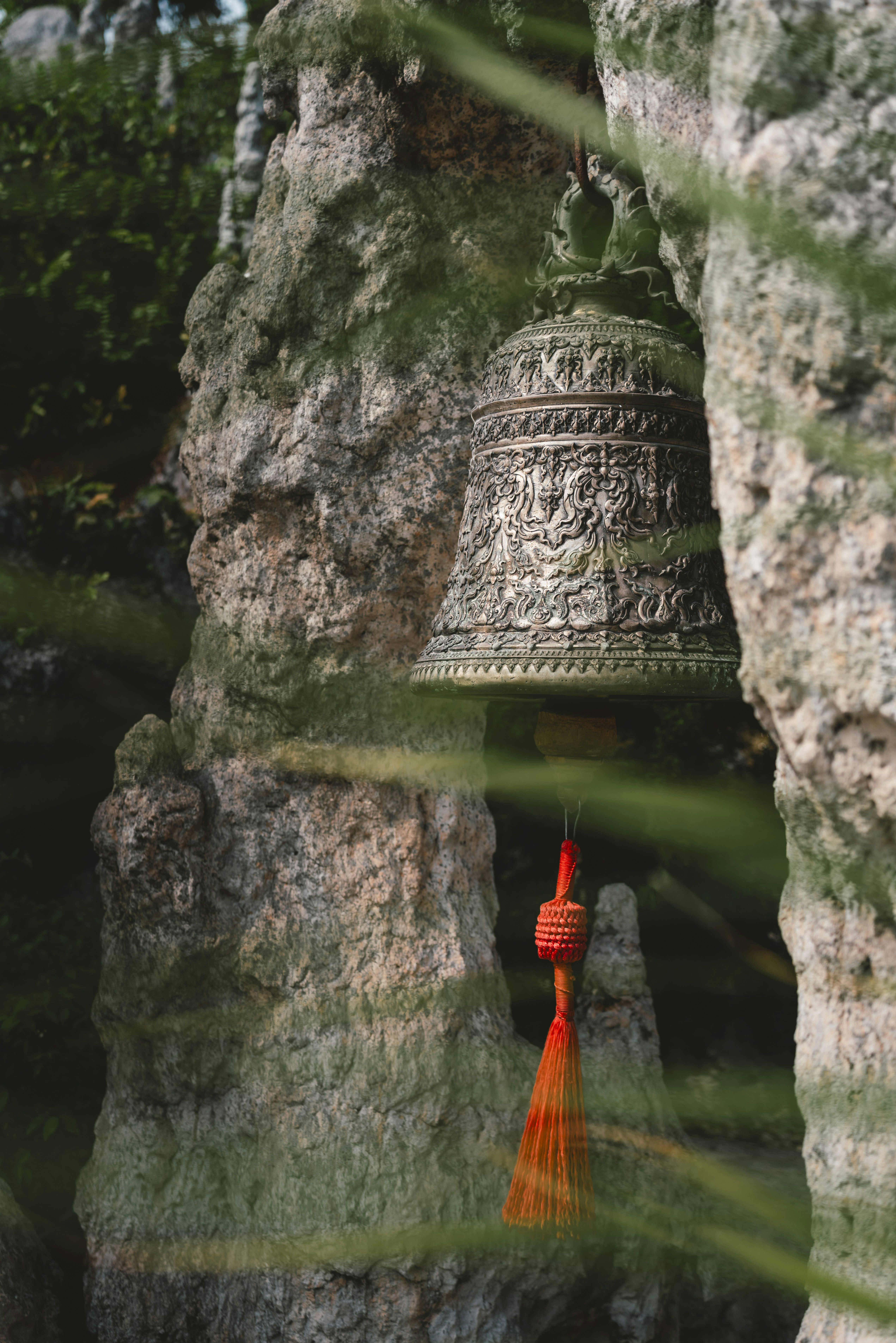 Ancient Bell Hidden Between Stone Pillars