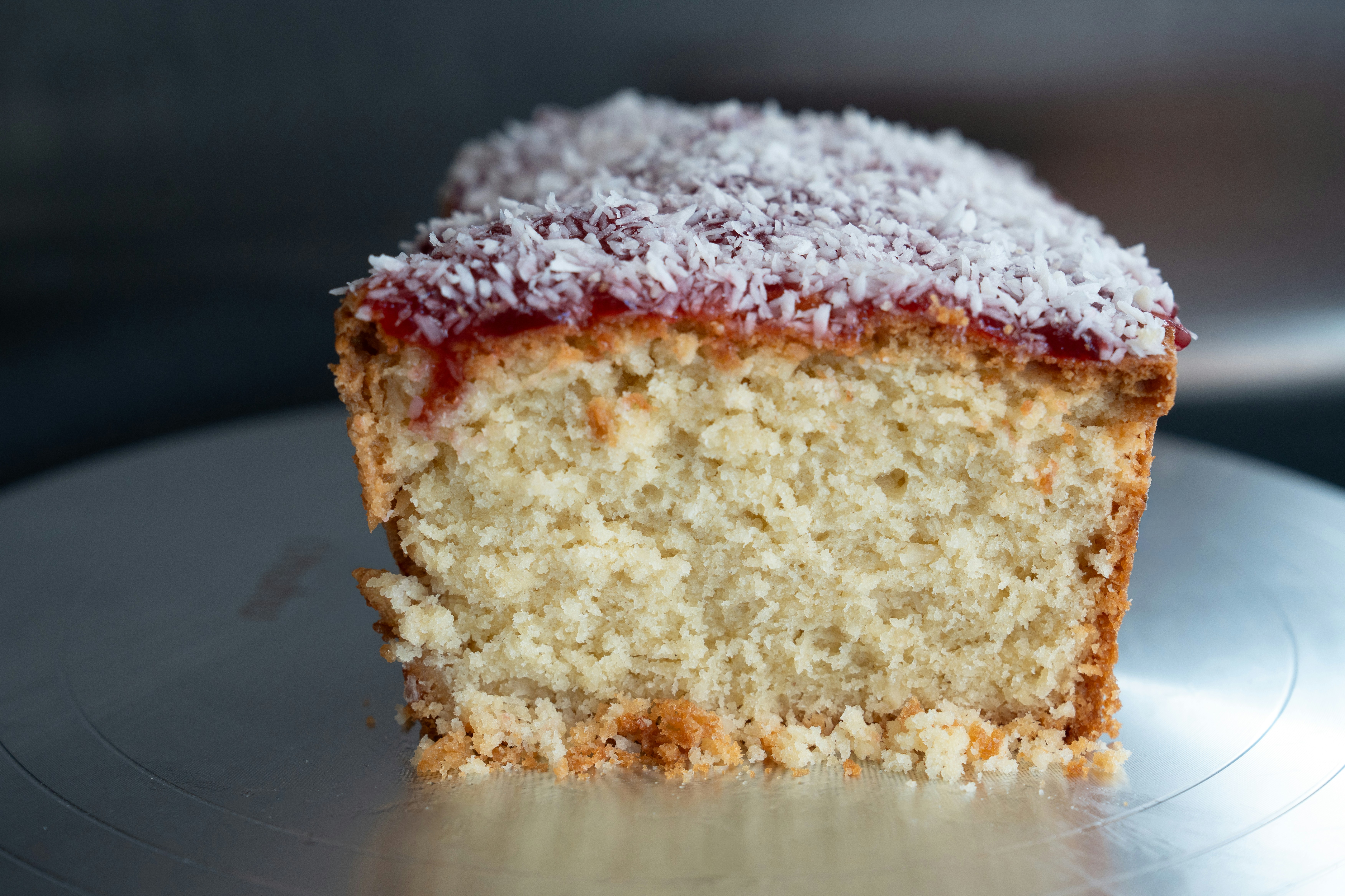 Sugared Summit: A Raspberry-Glazed Slice Anchoring a Marble-Plate Moment