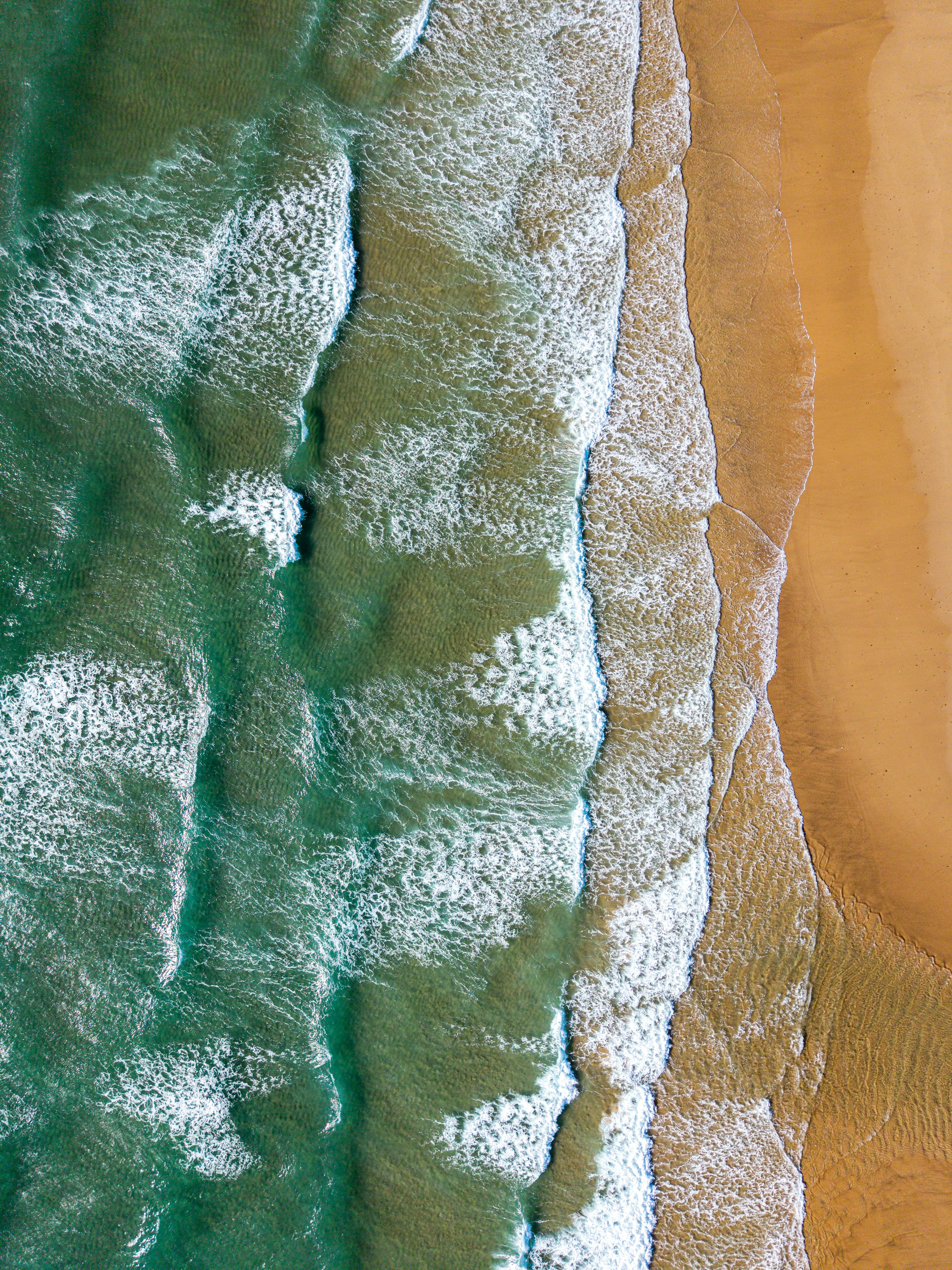Coastline Ribbon: Aerial Tide Patterns on a Golden Shore