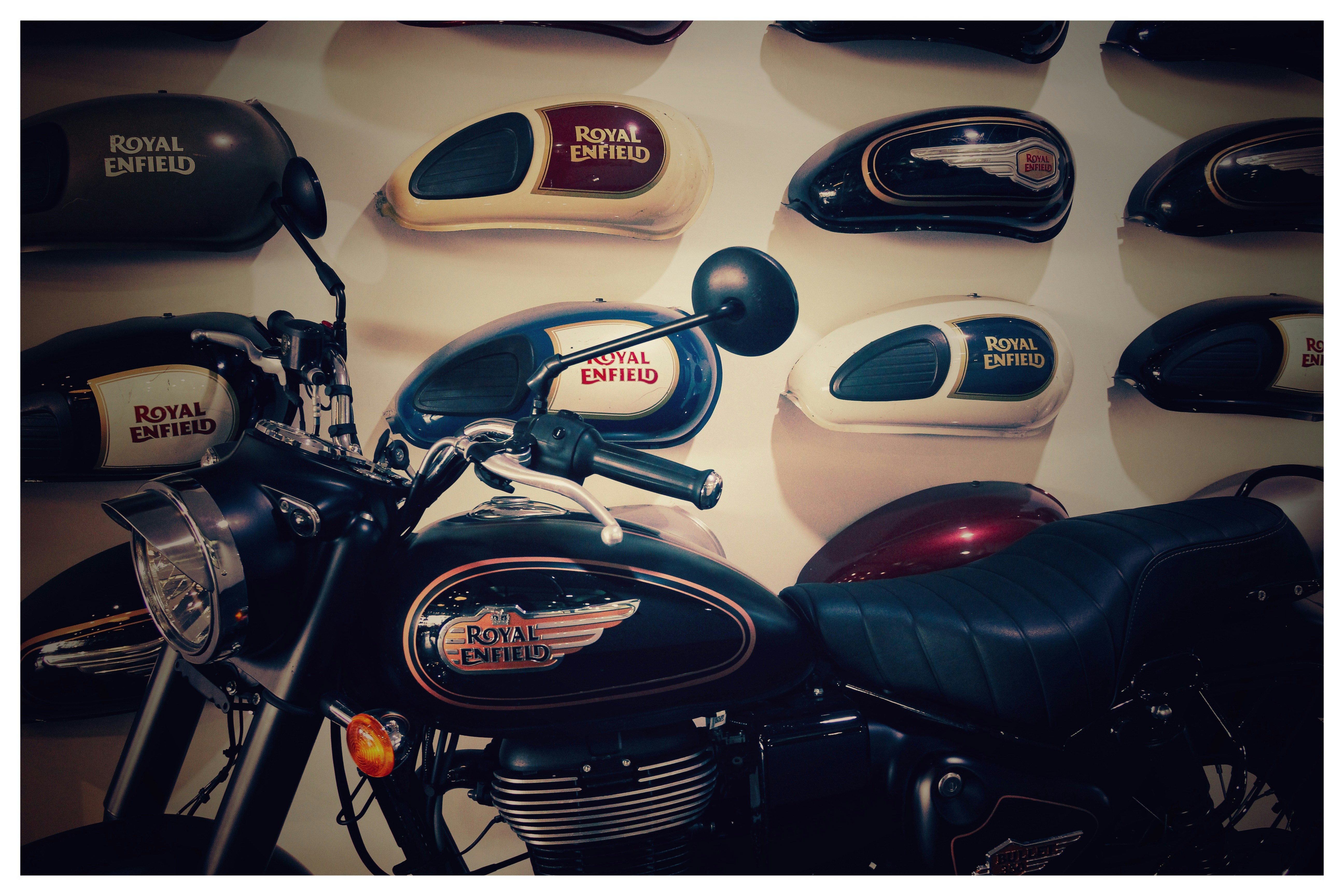 Replica Royal Enfield showroom: a vintage bike with row of emblems on wall