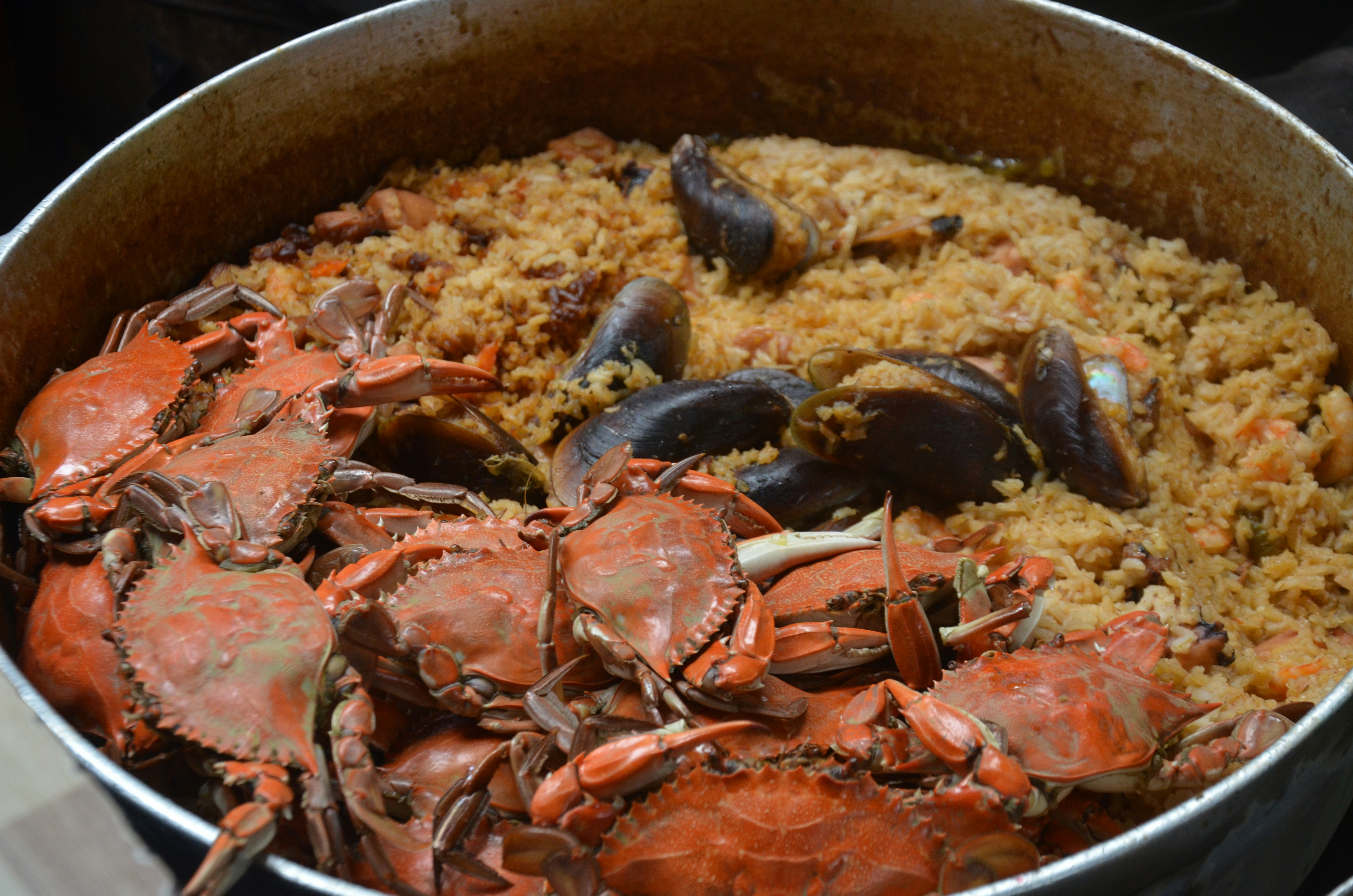 Crab Feast in a Rustic Pot: Red Shells and Dark Claws in Brown Rice