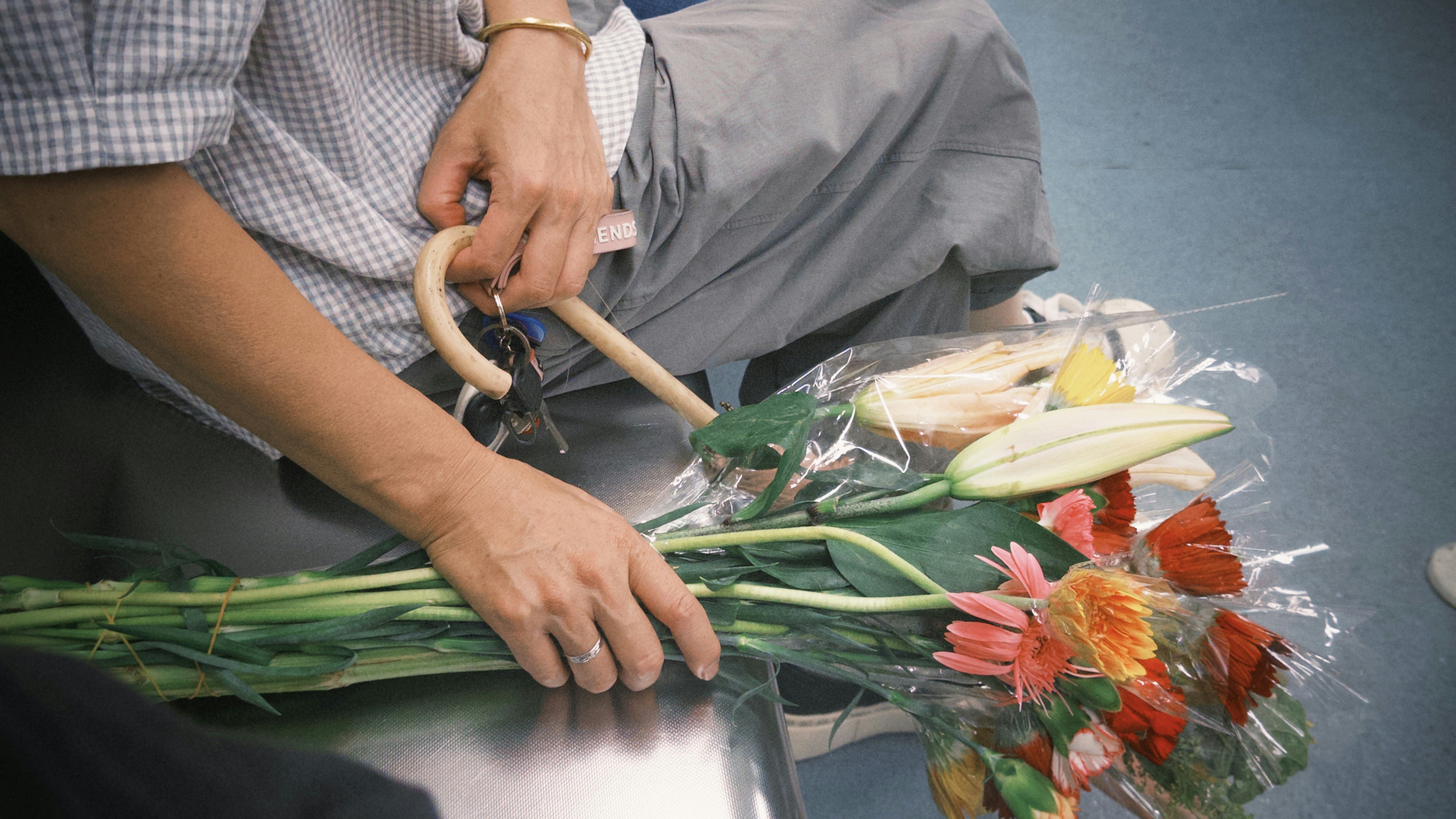 Bouquet Pause: Handful of Flowers Resting on Metal Surface