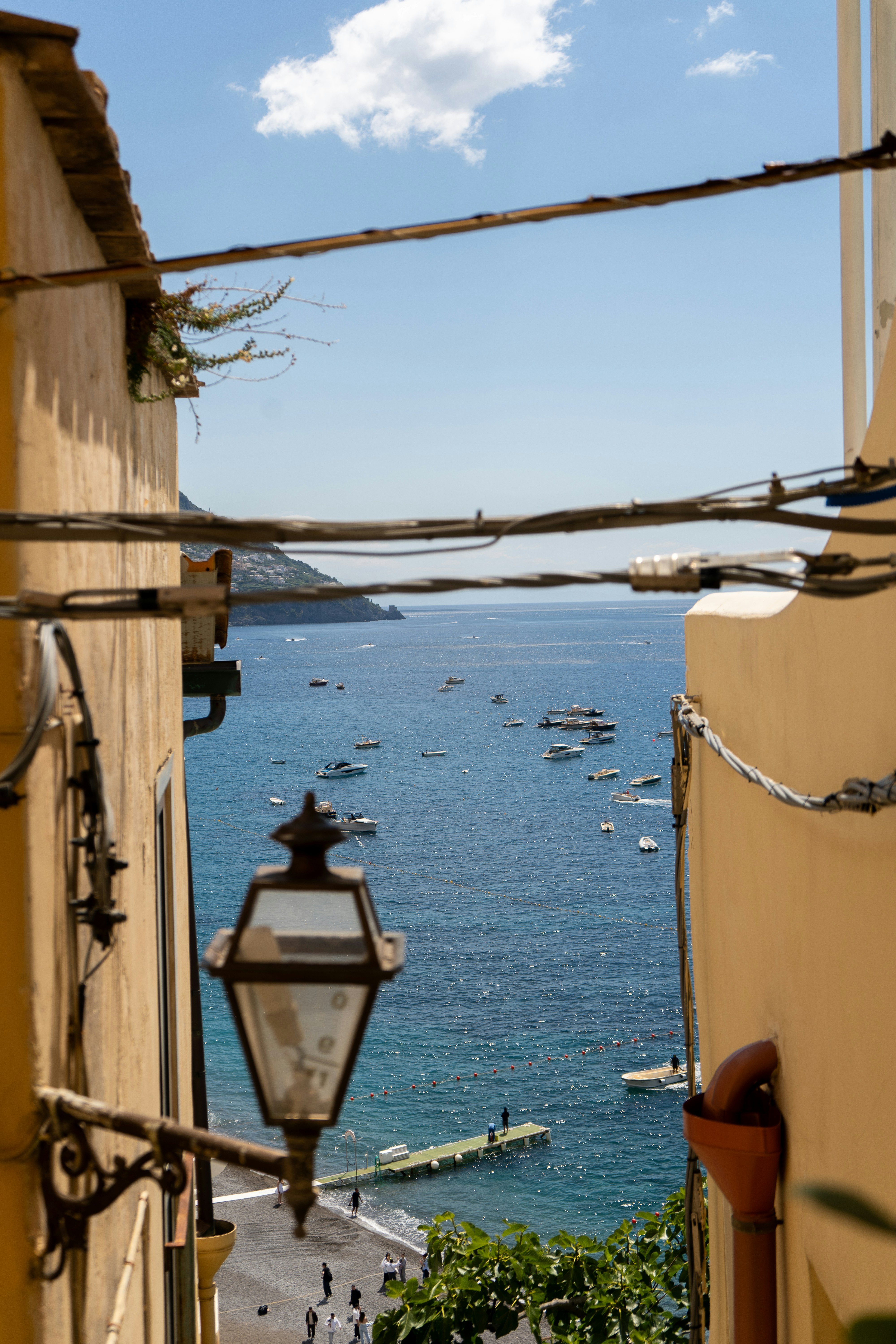 Staircase to the Sea: A Sunlit Alley Framing a Mediterranean Harbor