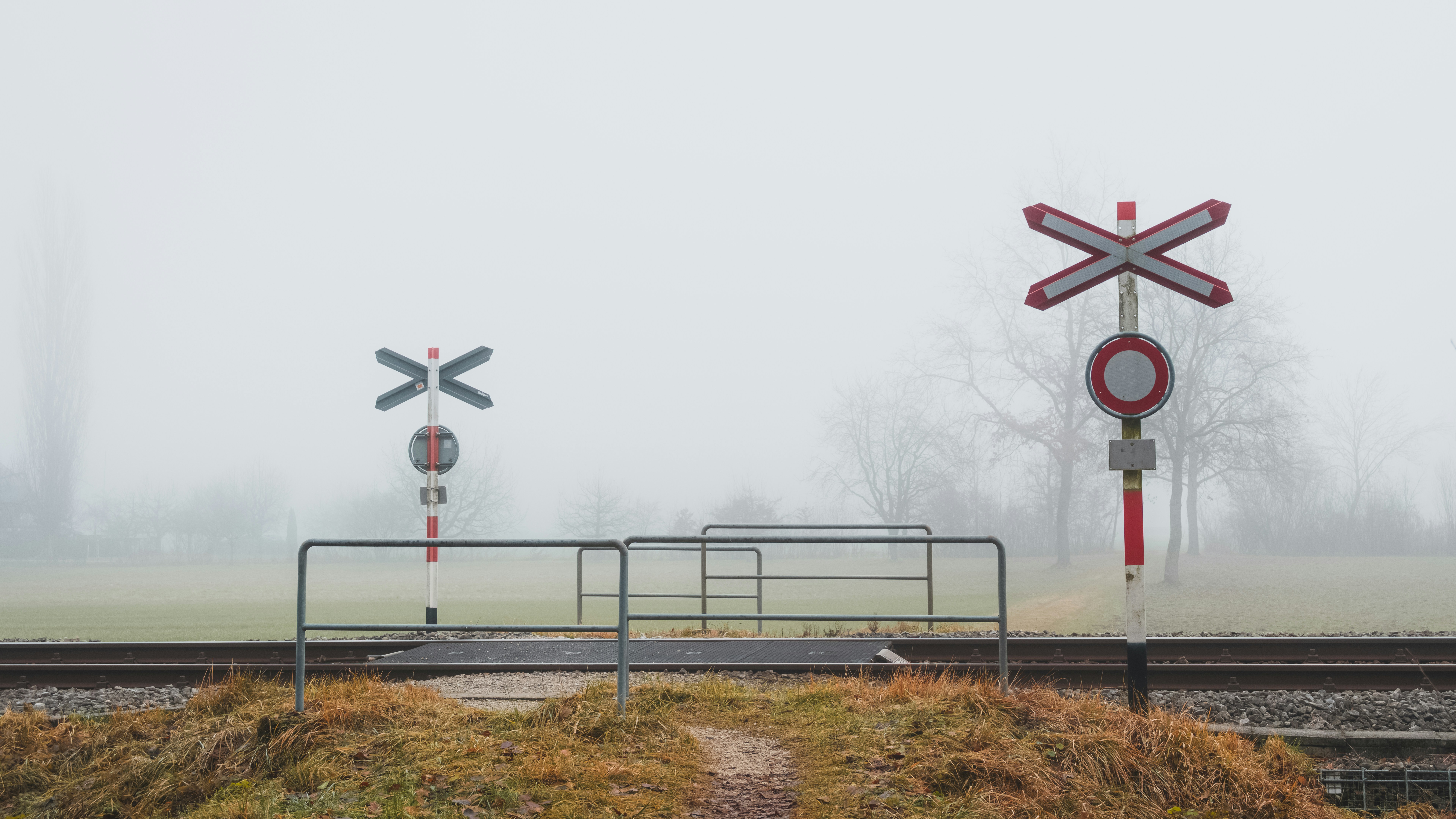 Mist over the Crossing: Quiet Rails at Dawn