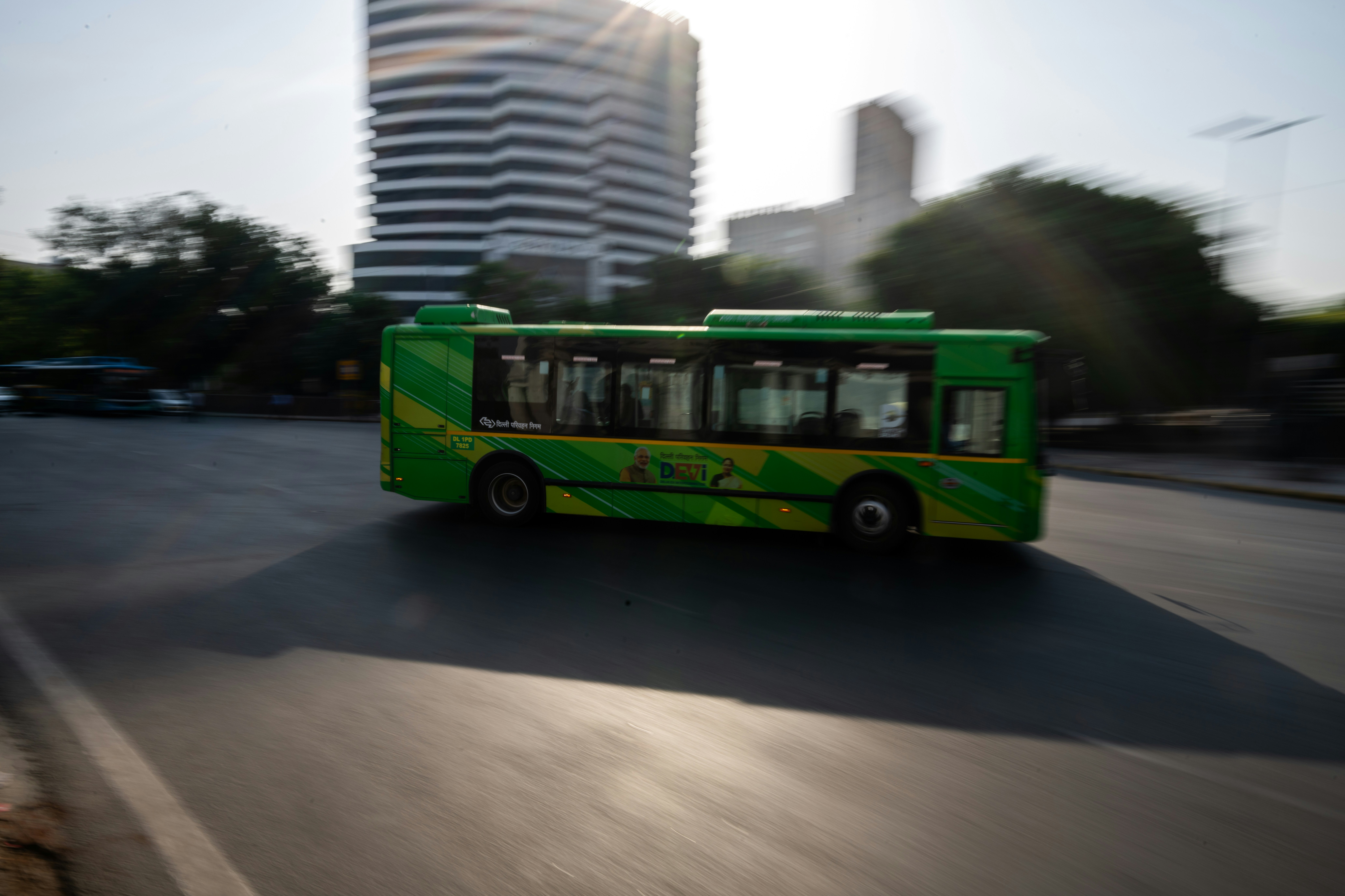 Green City Bus in Motion: A Blurred Urban Glide