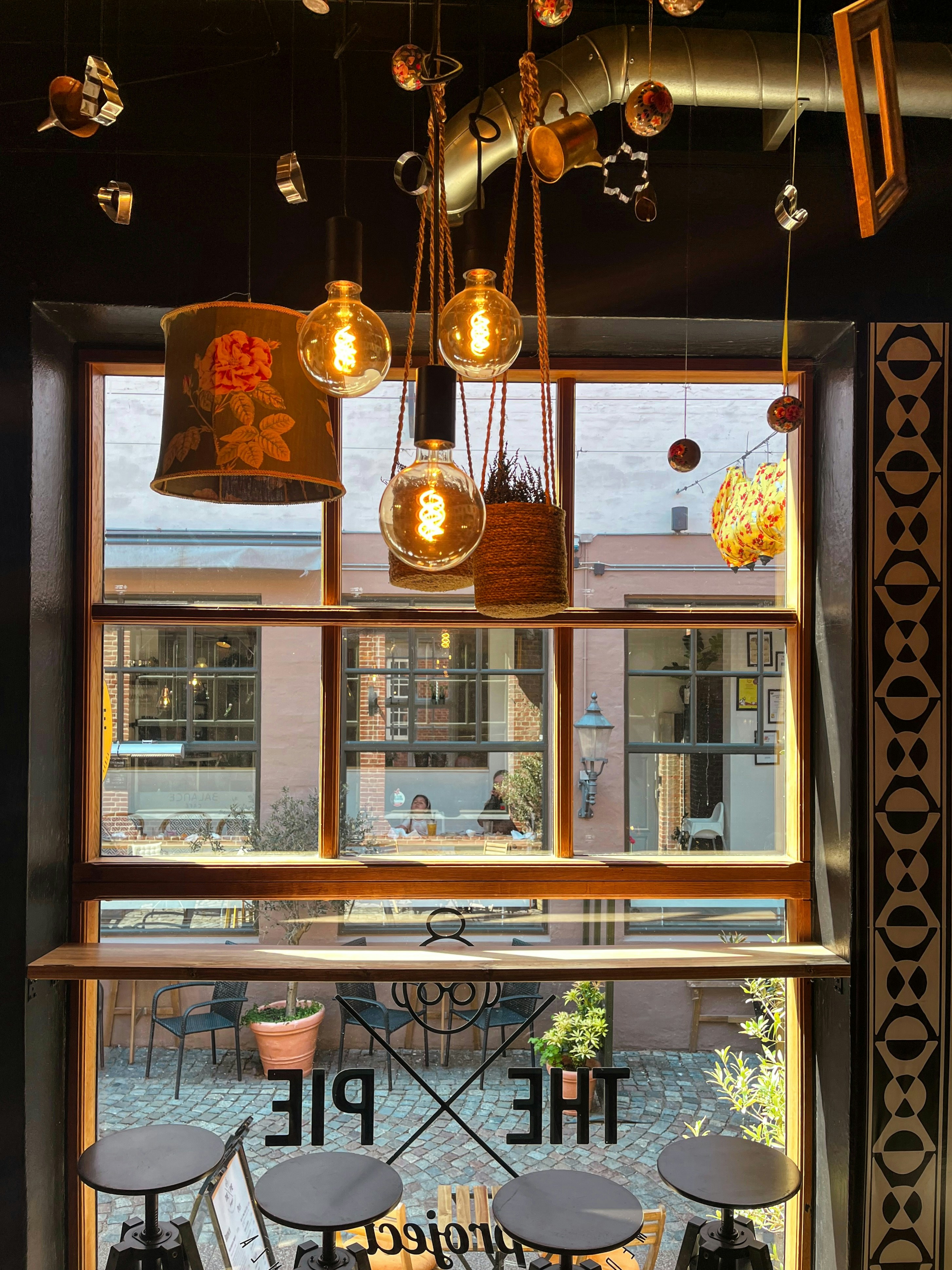 Hanging Lanterns and Sunlit Window Café