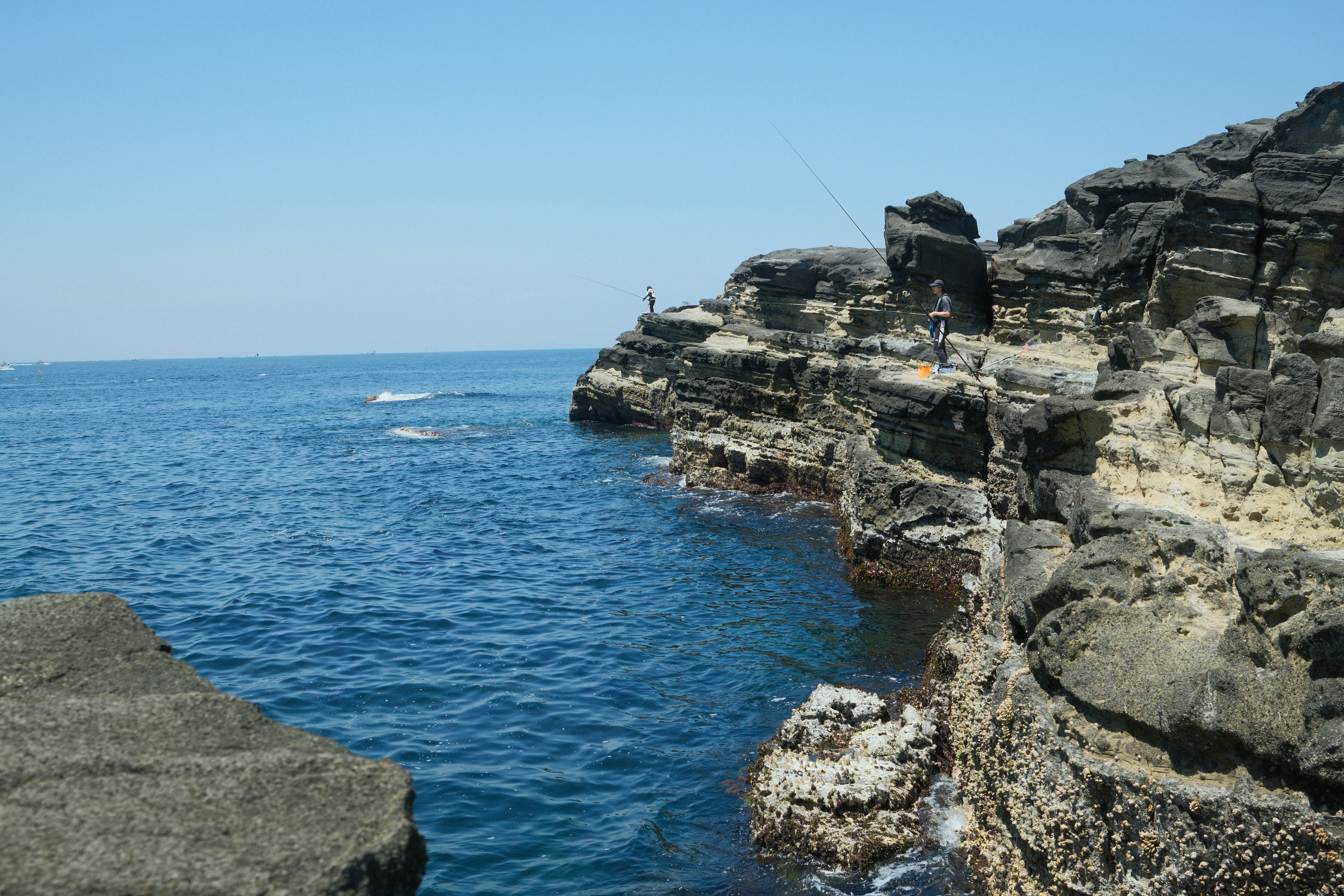 Rocky coastline with blue ocean and clear sky