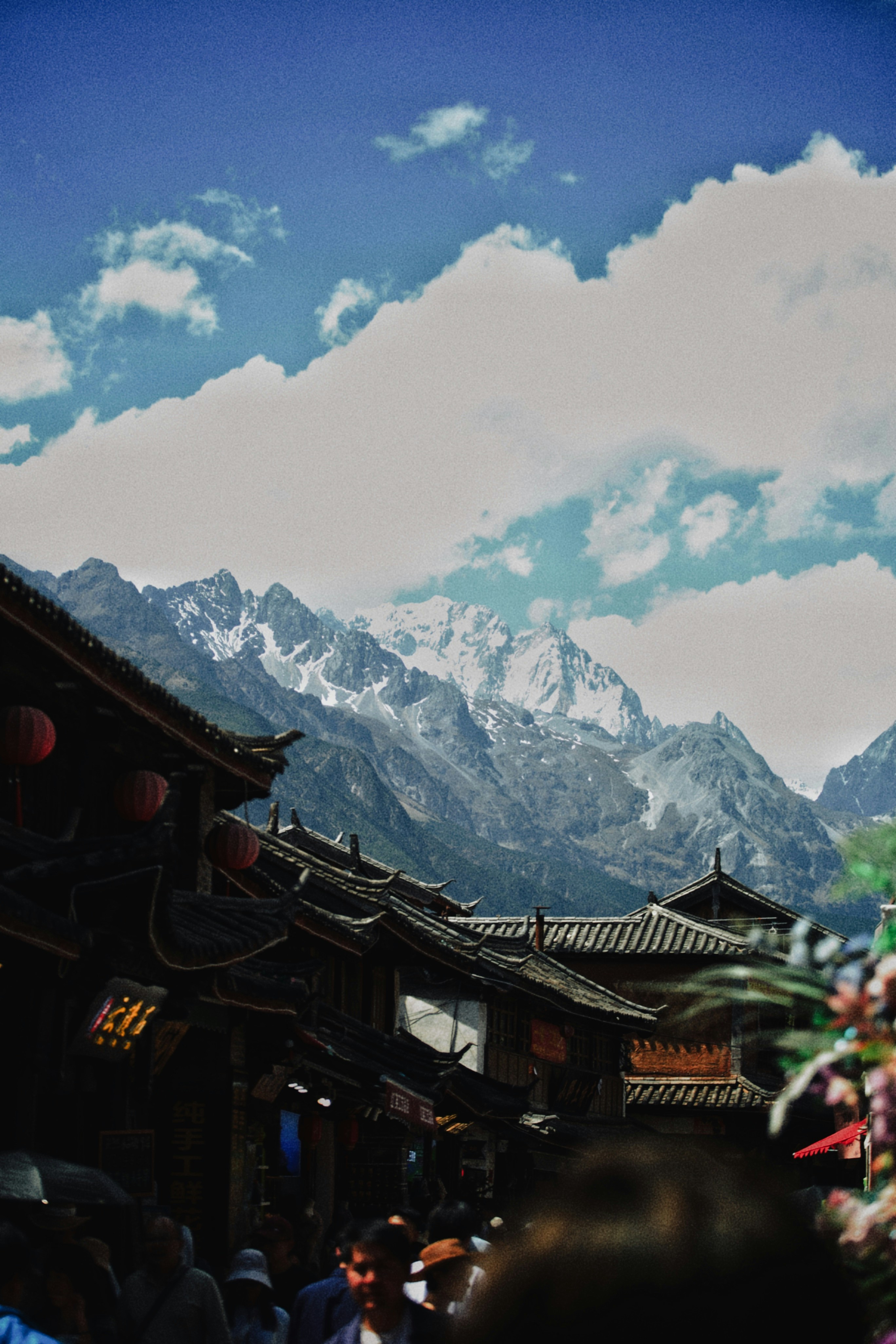 Snow-kissed Peaks Over a Lantern-lit Alley